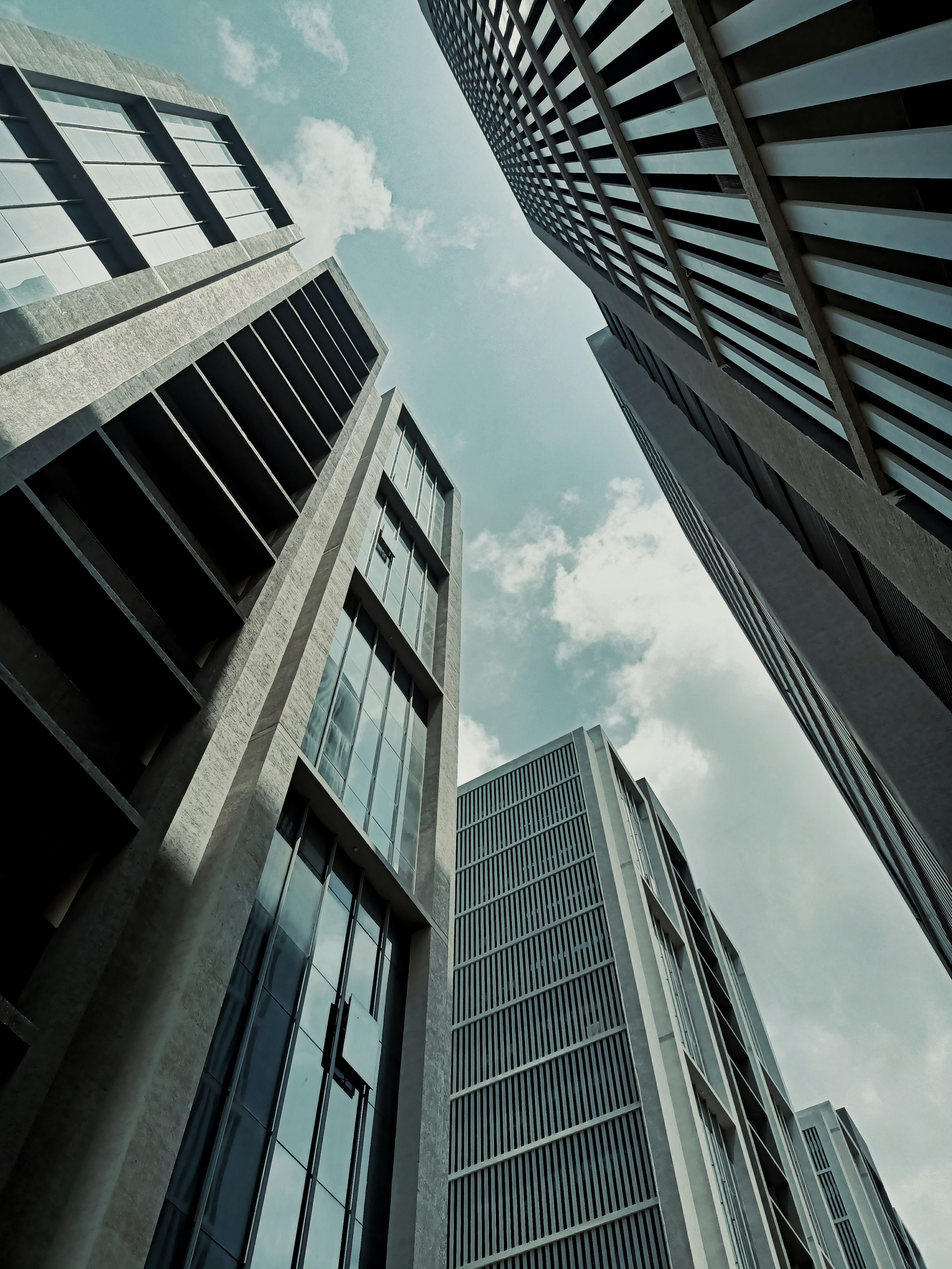 Looking up at tall buildings in a city photo – Free Grey Image on Unsplash