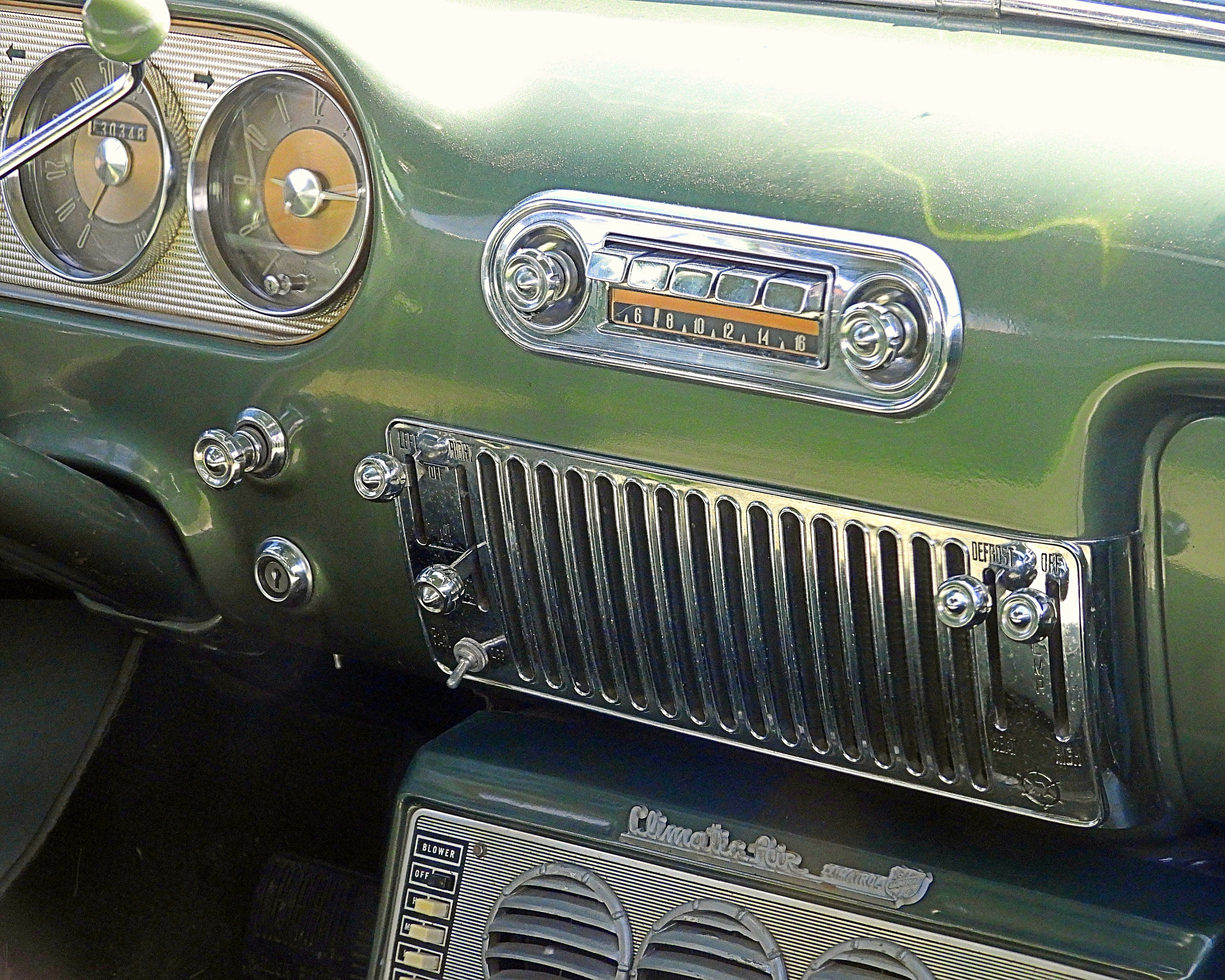 Classic car dashboard featuring retro dials and chrome details.