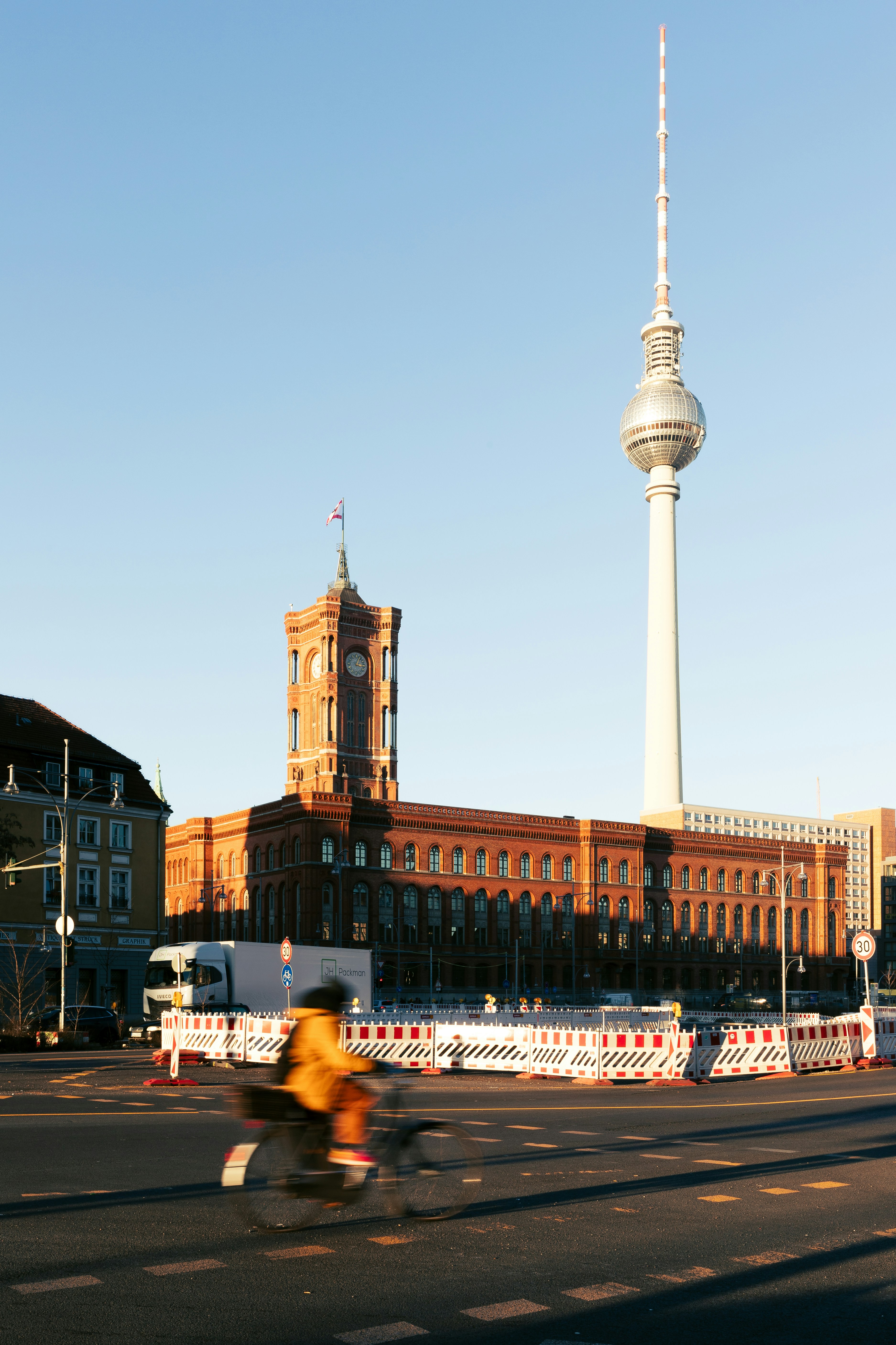 Vertical Contrast: Berlin's Fernsehturm Meets a Brick Clock Tower at Dawn