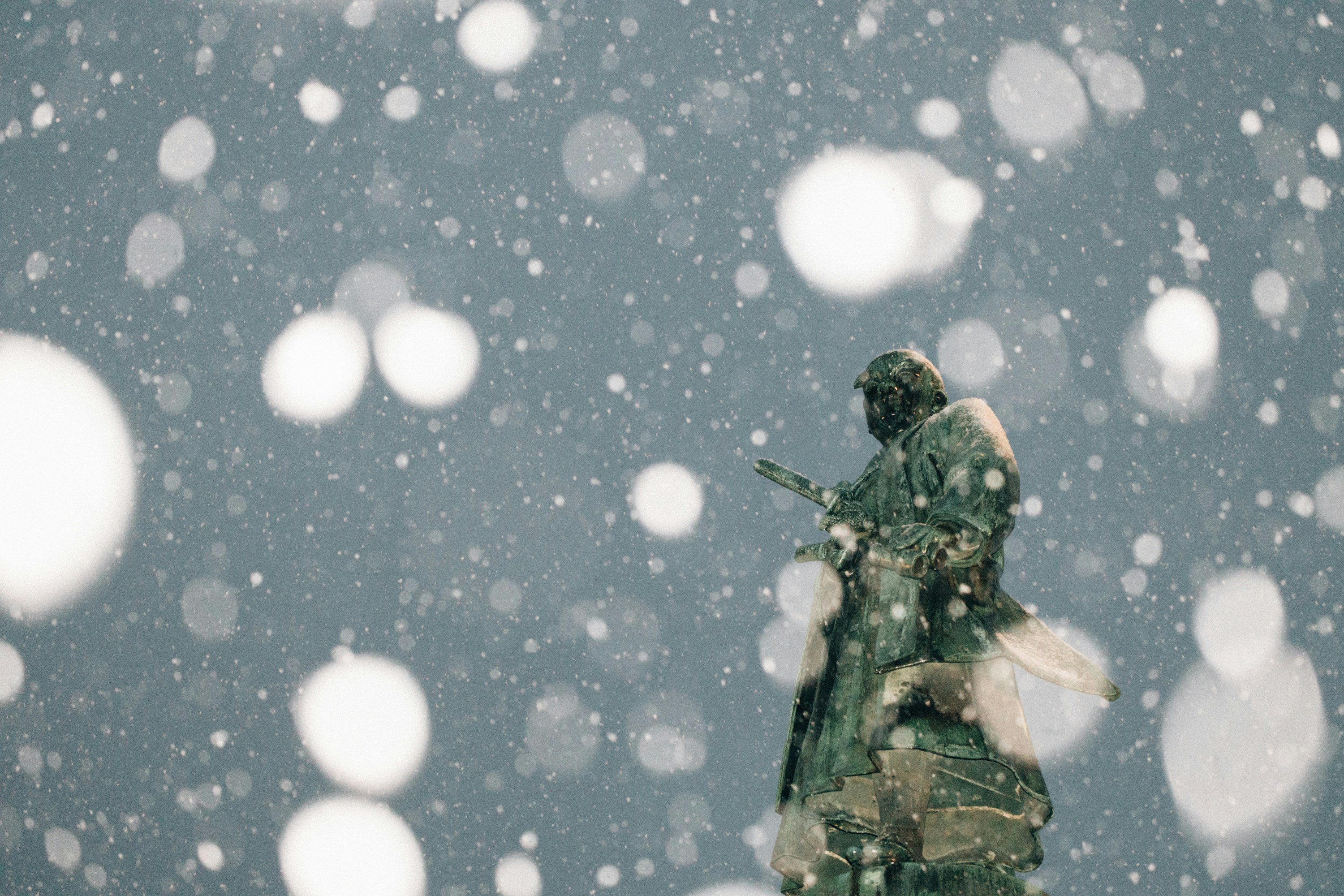 A statue of a man holding a gun in the snow photo – Free Snow Image on ...