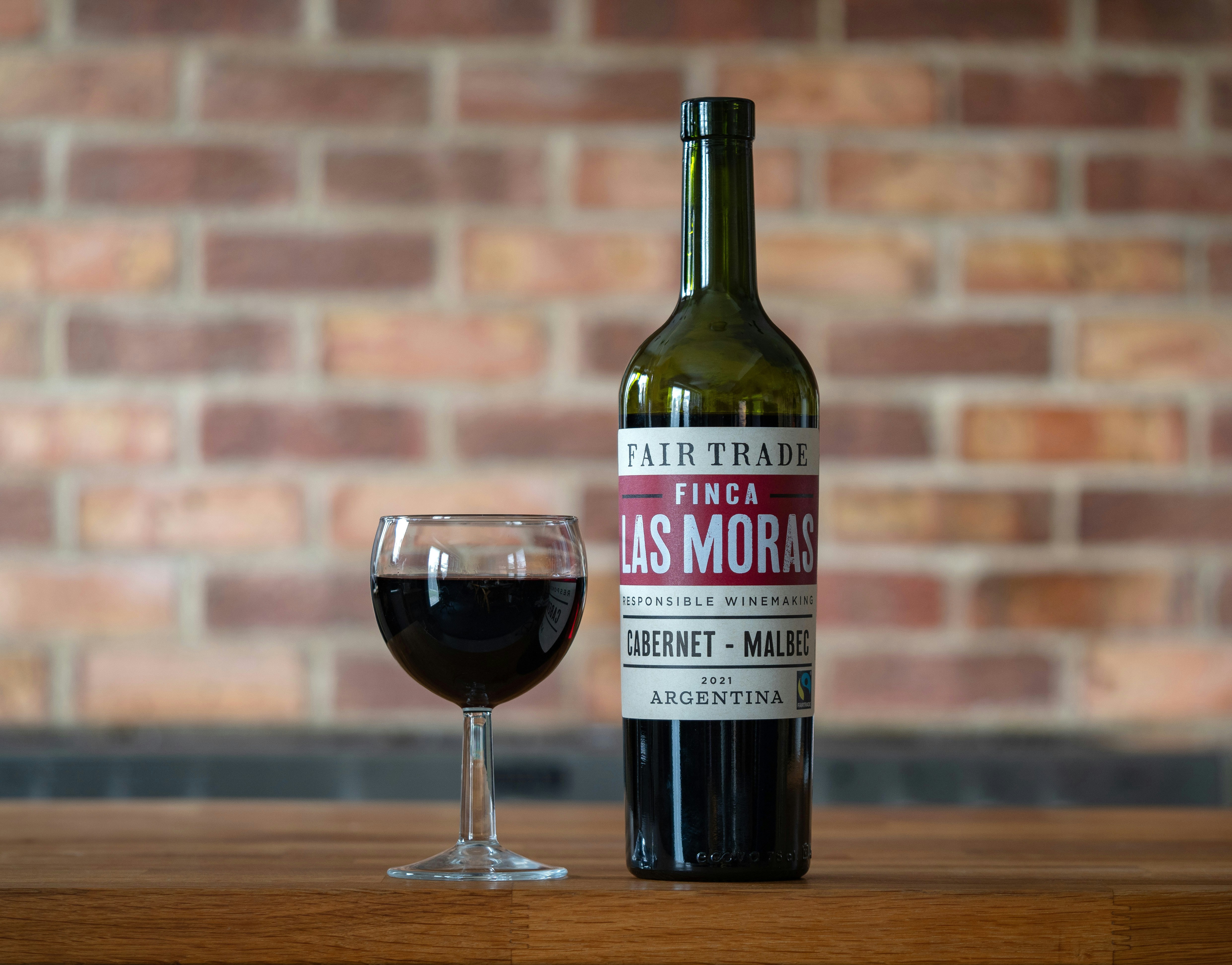 Brick-Warmed Still Life: Finca Las Moras Cabernet-Malbec on a Wooden Bar