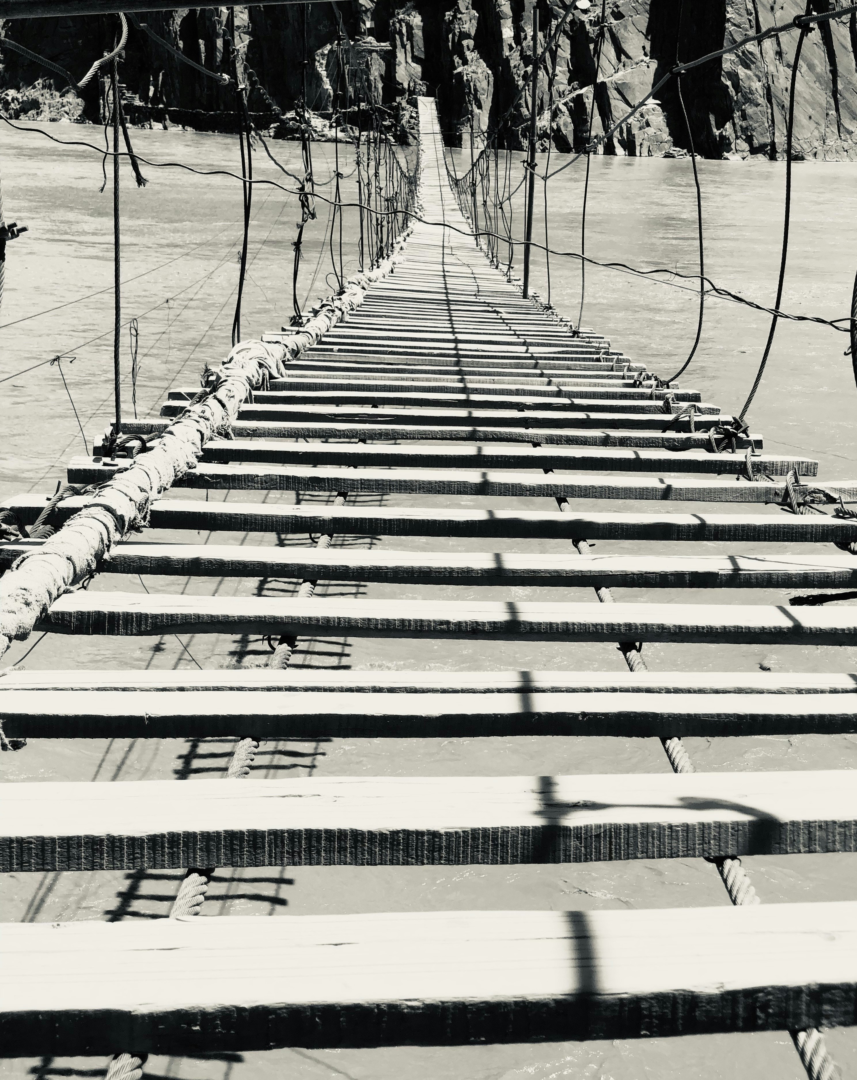 A very long bridge with lots of wires above it photo – Free Wallpaper ...