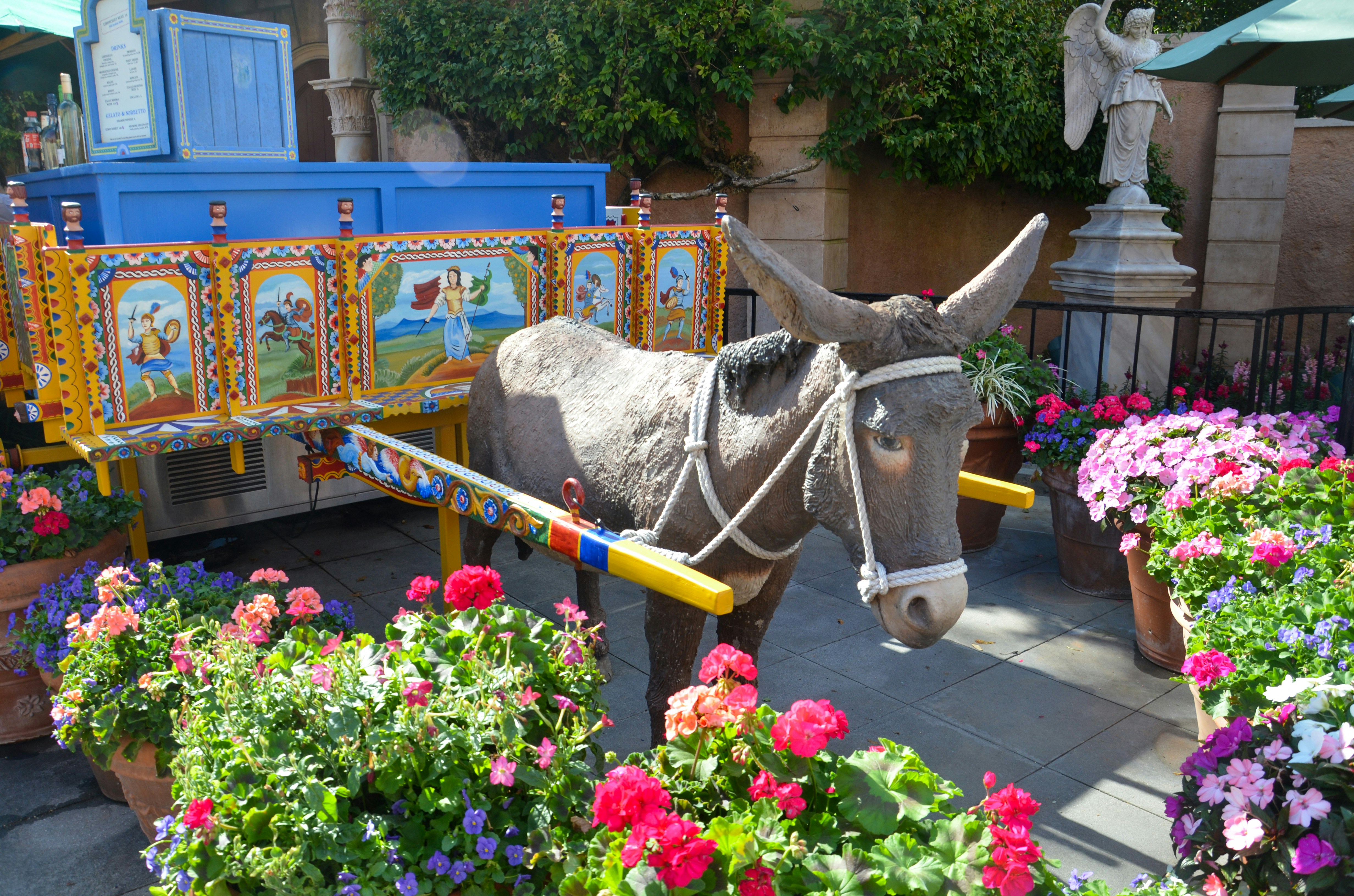 Donkey in a Courtyard of Color: A Painted Wagon Framed by Florals