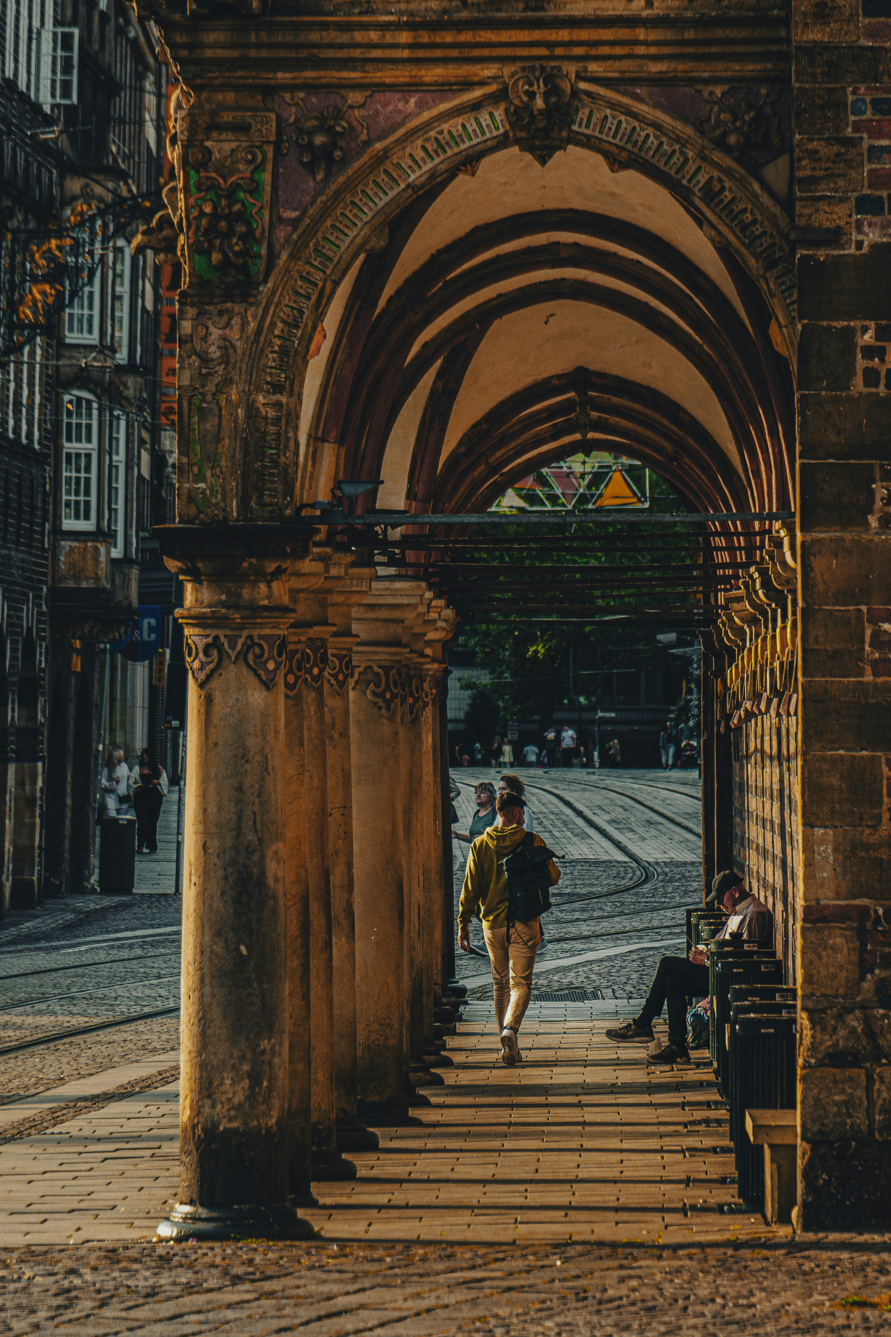 Archway Corridor Walk: A lone traveler under the historic arches
