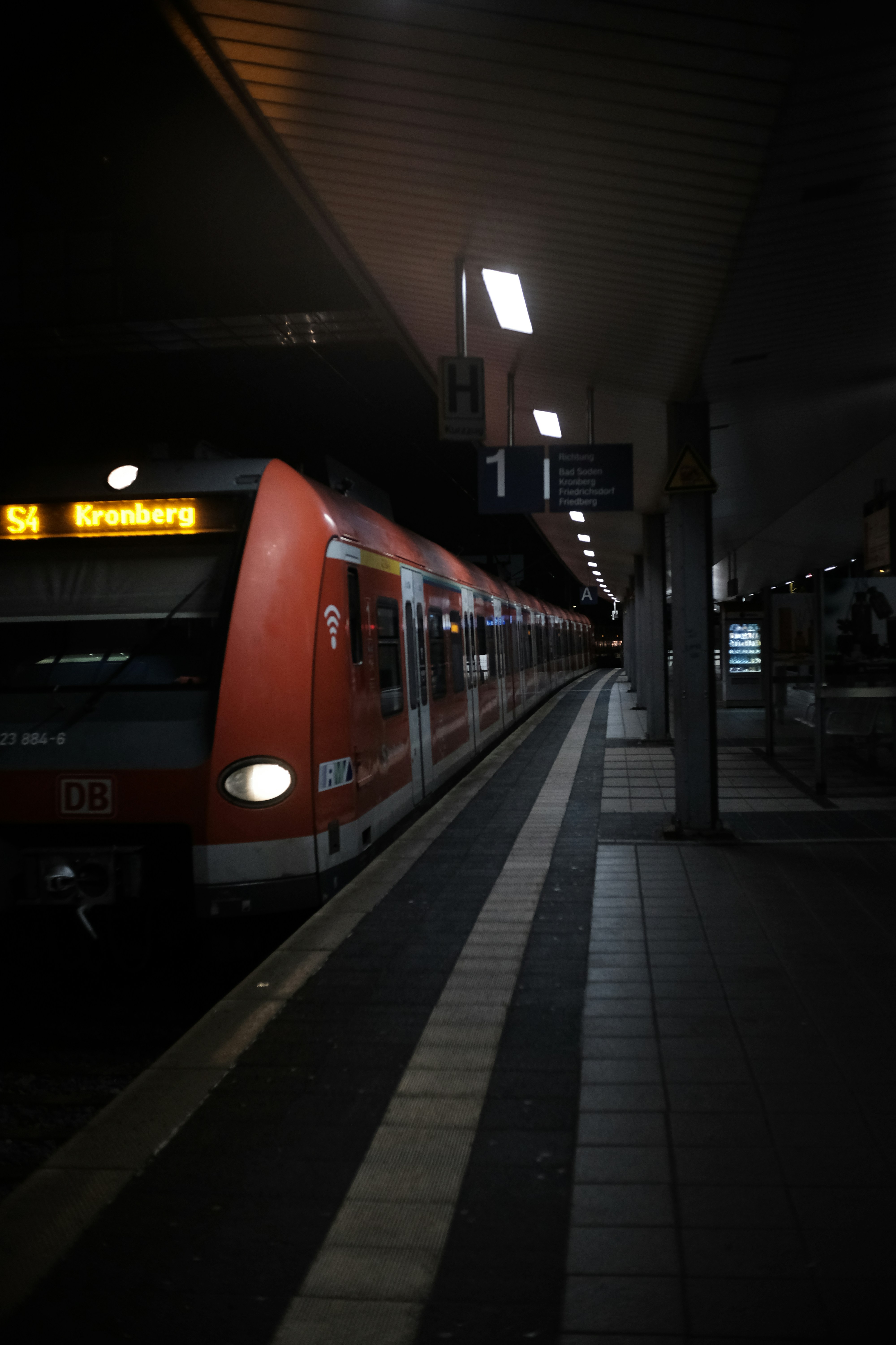 A red train pulling into a train station photo – Free Train Image on Unsplash