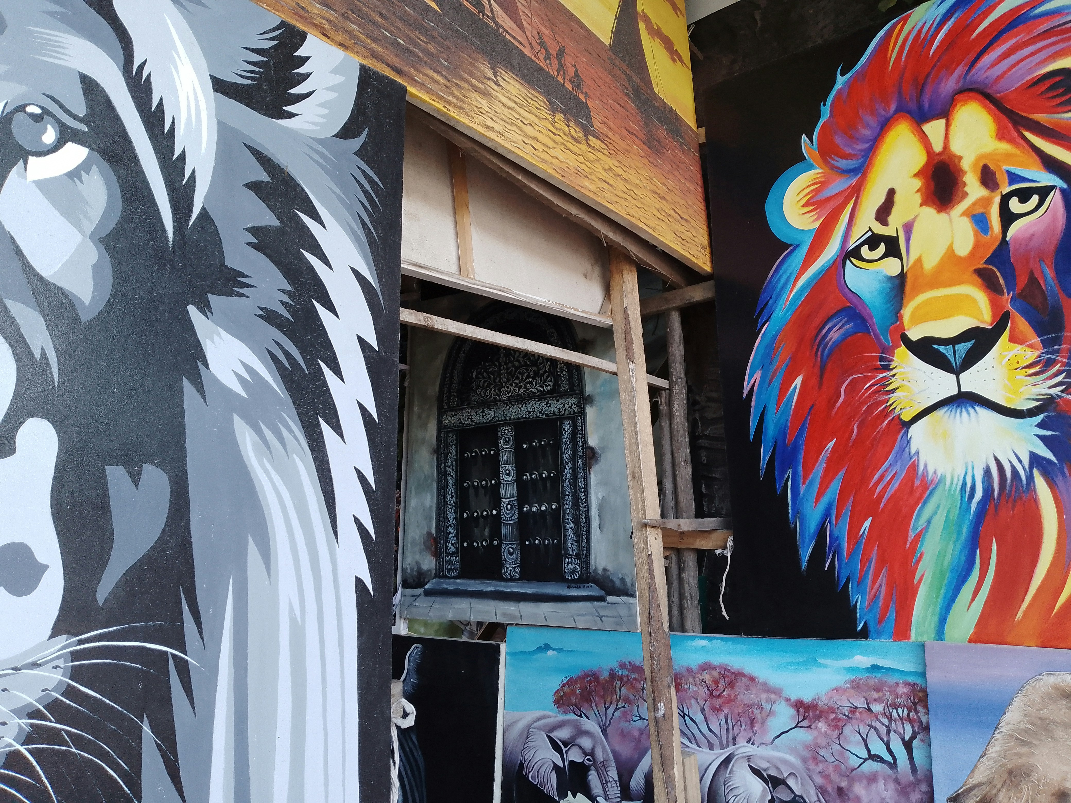Twin Beasts in Graffiti: Neon Lion Faces Off with a Grayscale Wolf by a Quiet Doorway
