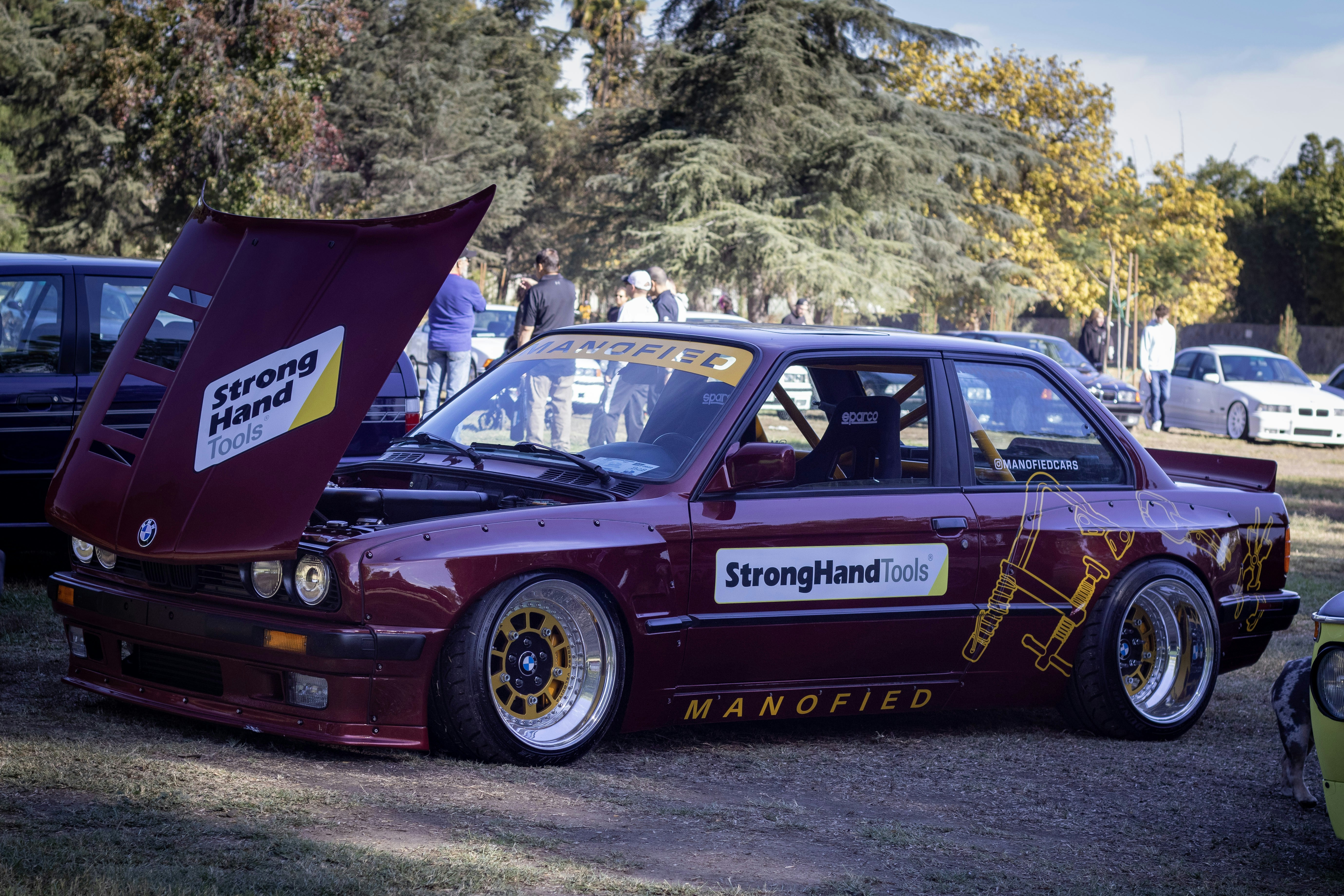 A maroon car parked next to other cars photo – Free Vehicle Image on ...