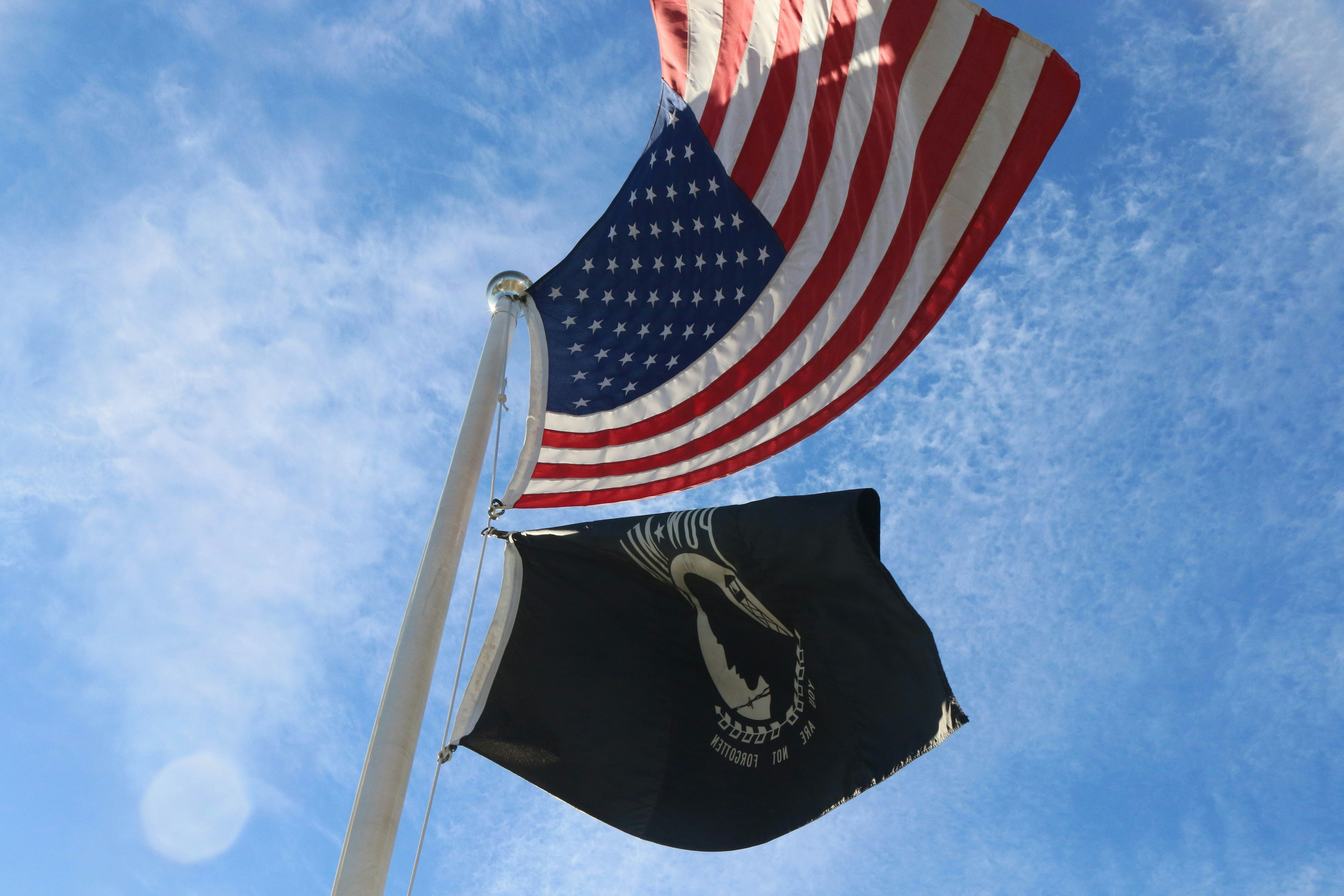 Windward Duo: Flags Against a Wide Blue Sky