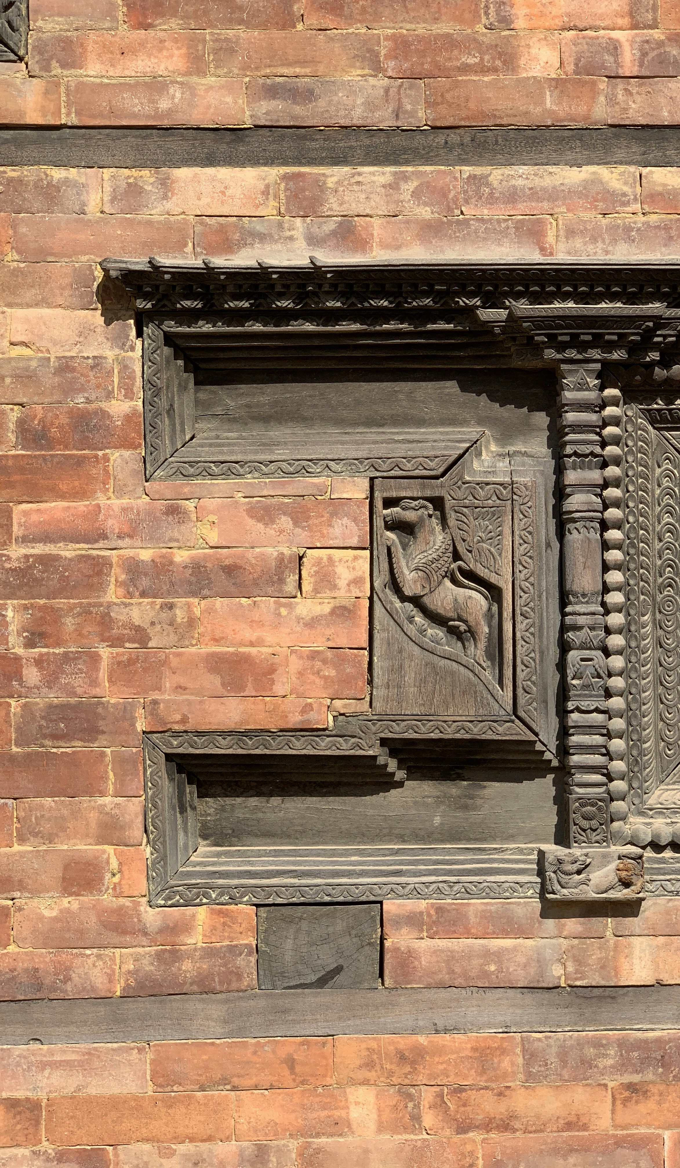 Dragon Frieze in Red Brick: A Quiet Moment of Architectural Carving