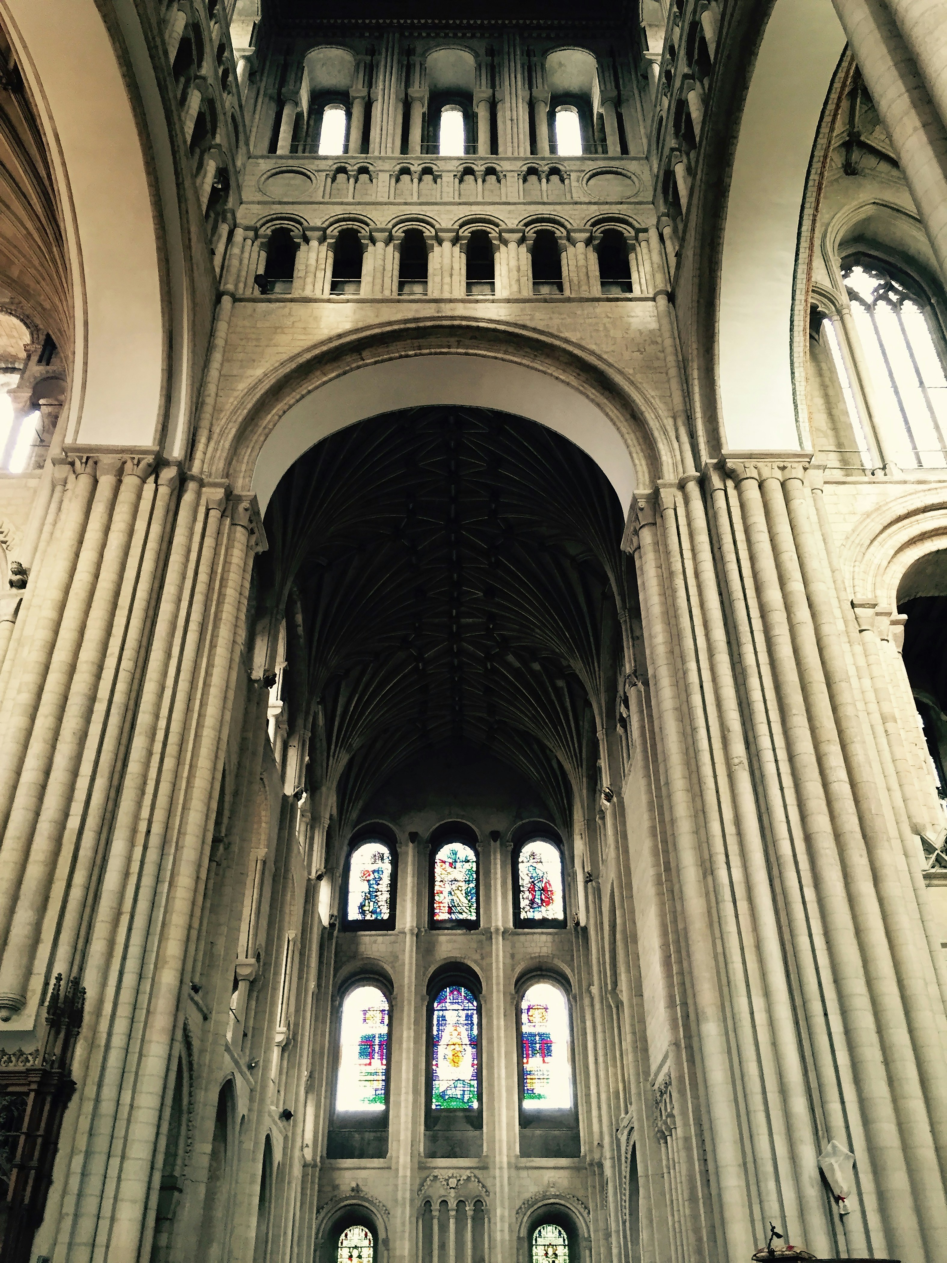 the interior of a large cathedral with stained glass windows