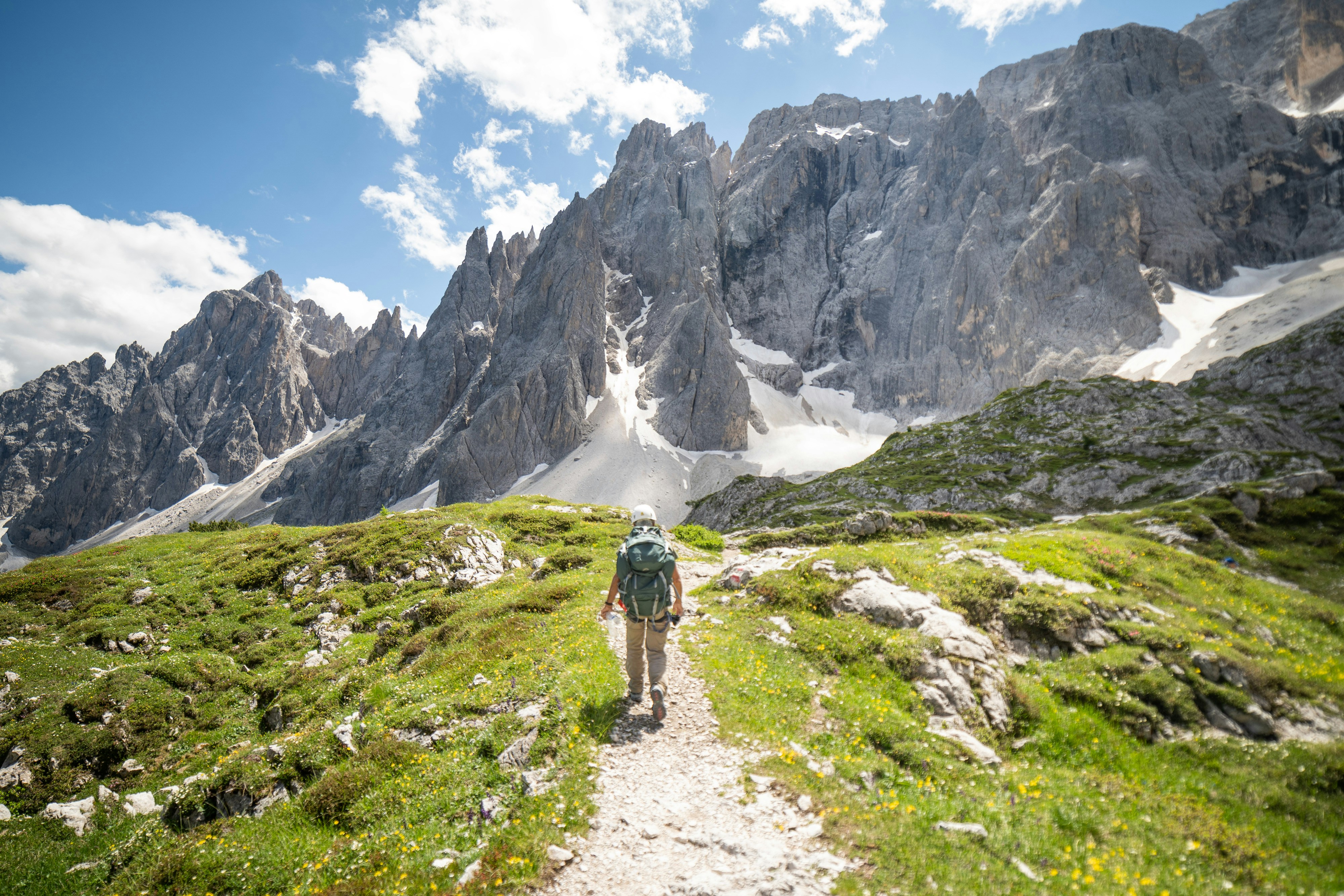 A man hiking up a trail in the mountains photo – Free Travel Image on ...