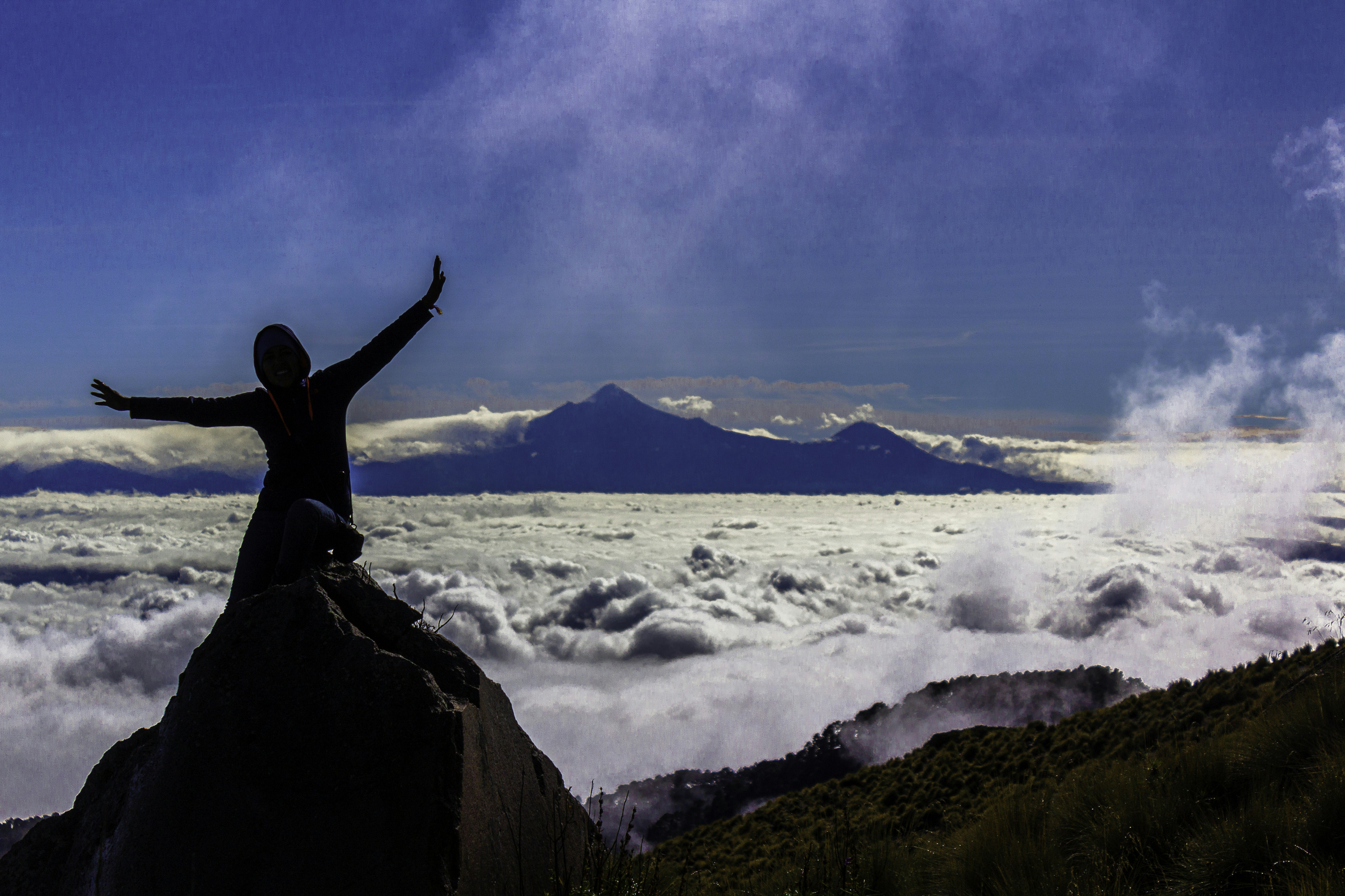 Arm-Raised Silhouette on a Ridge Above a Sea of Clouds at Dawn