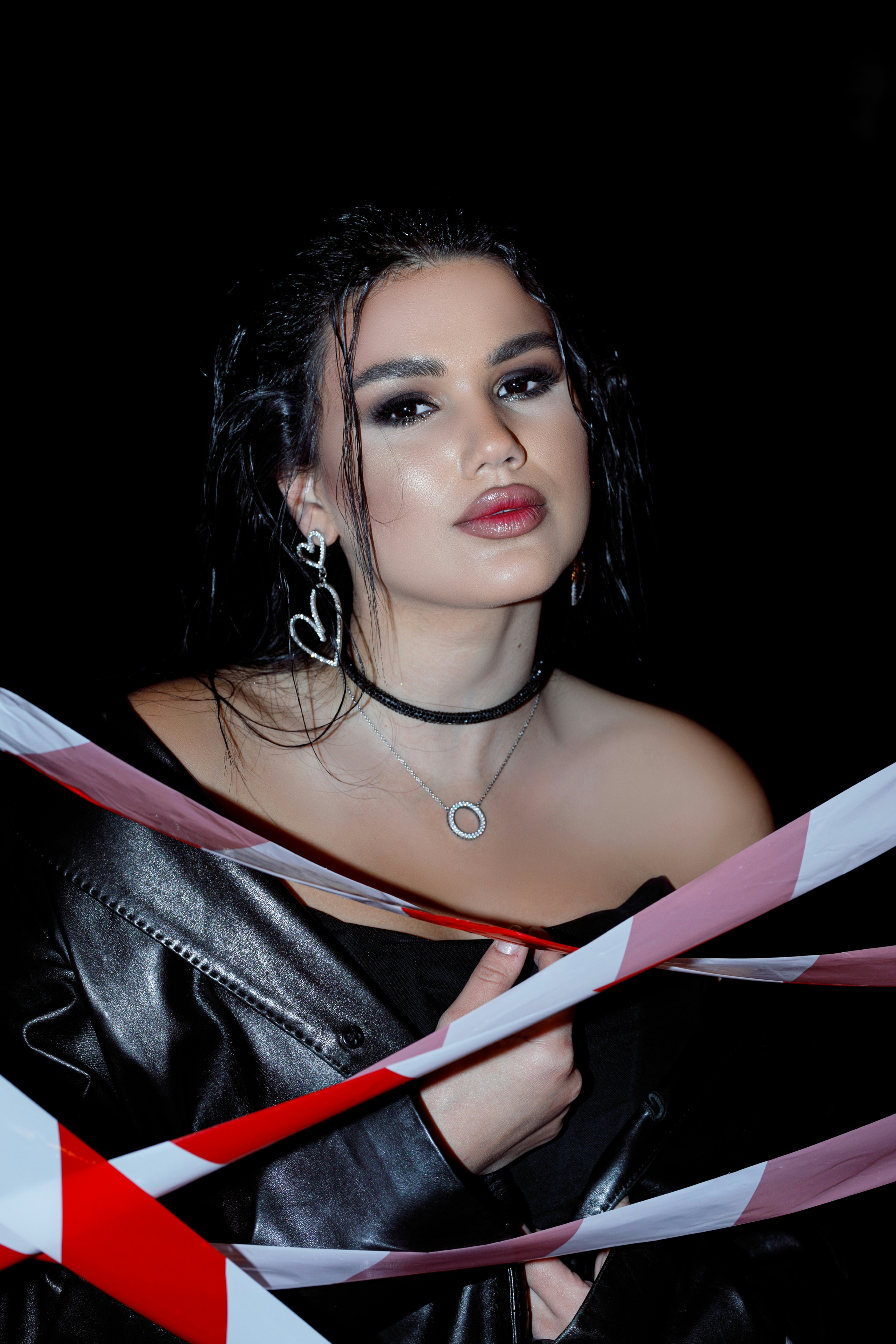 A woman in a leather jacket holding a pair of scissors photo – Free ...