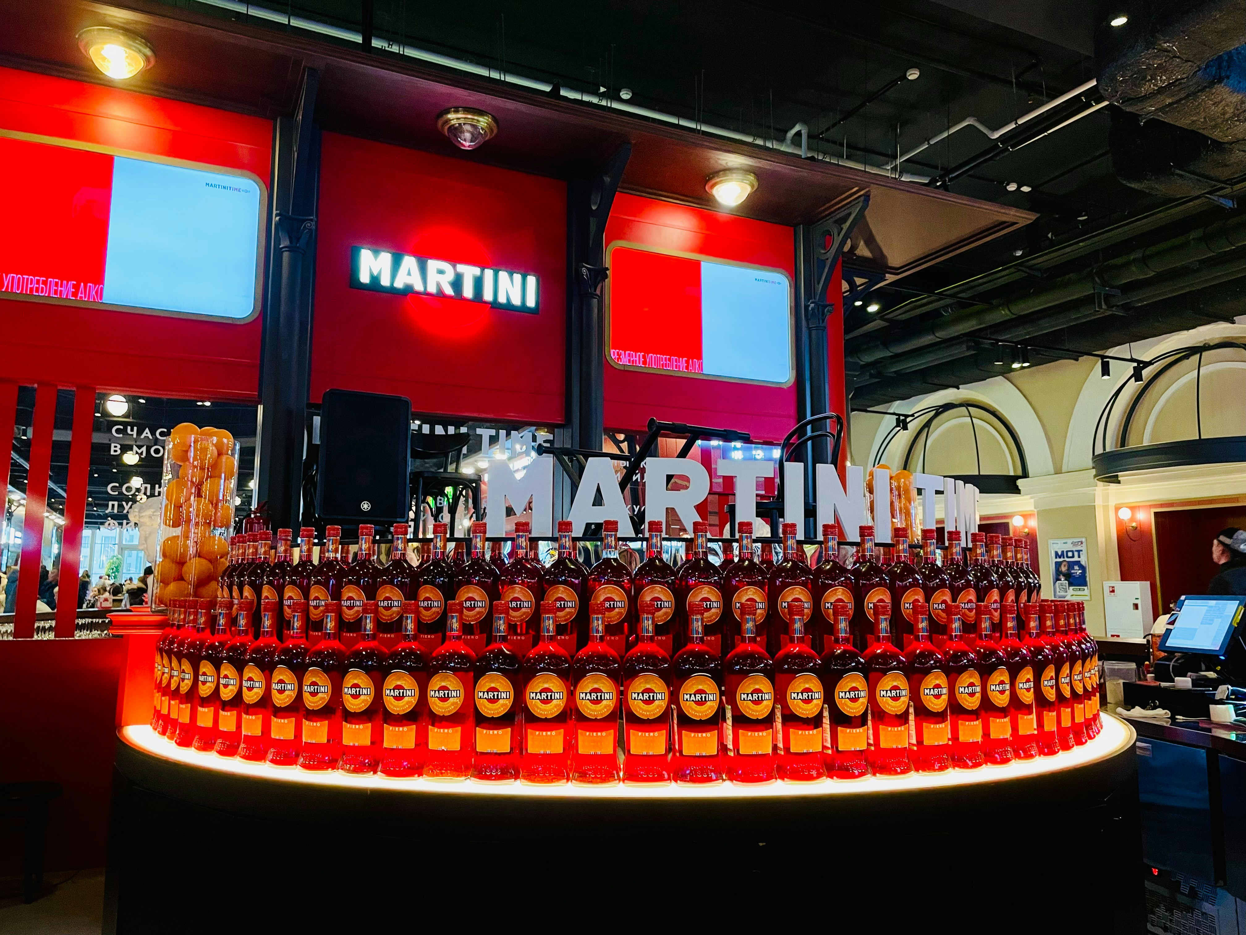 Martini Ring: Circular Bottled Display Under Red Neon