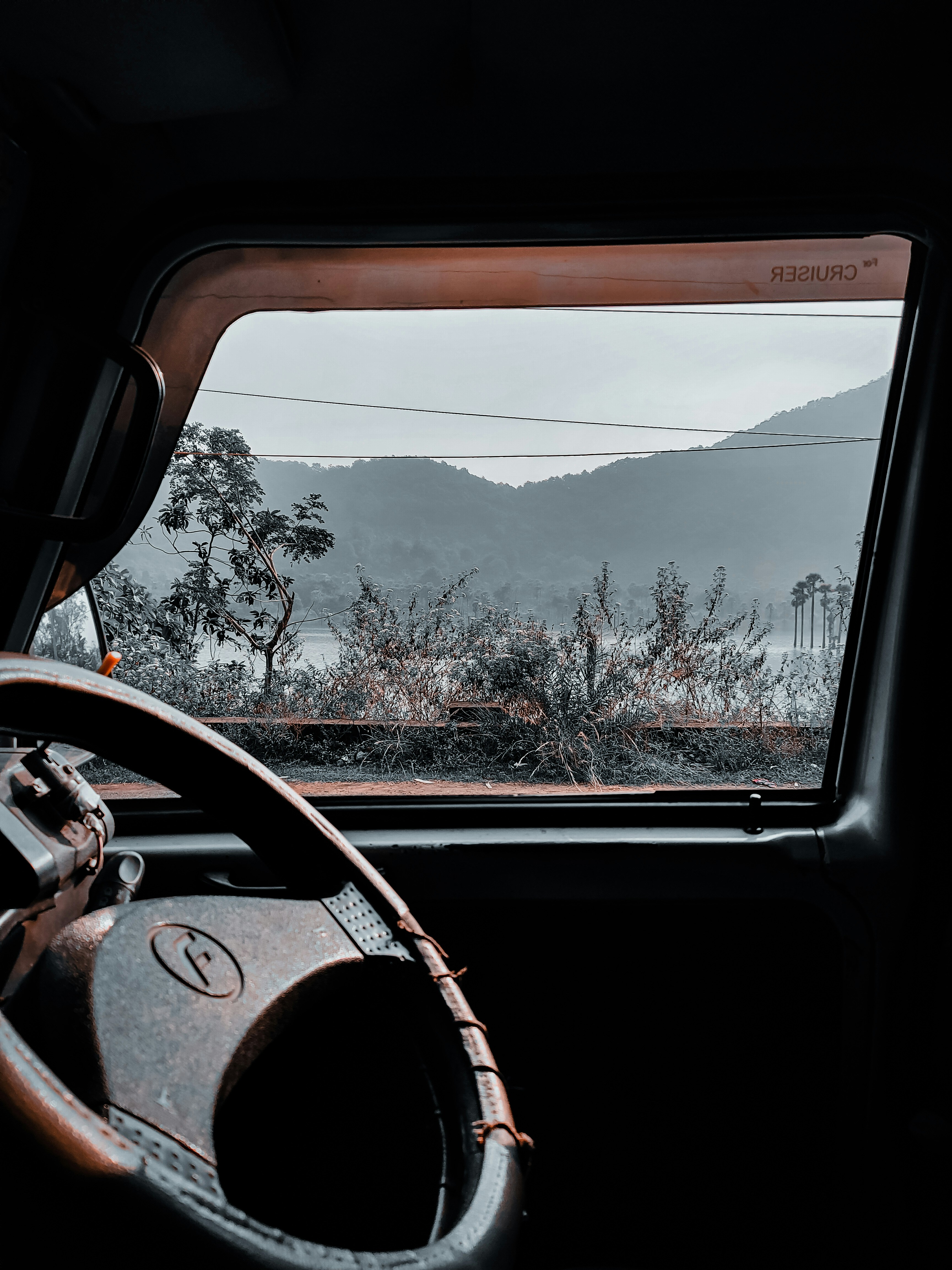 a view of a mountain from inside a vehicle