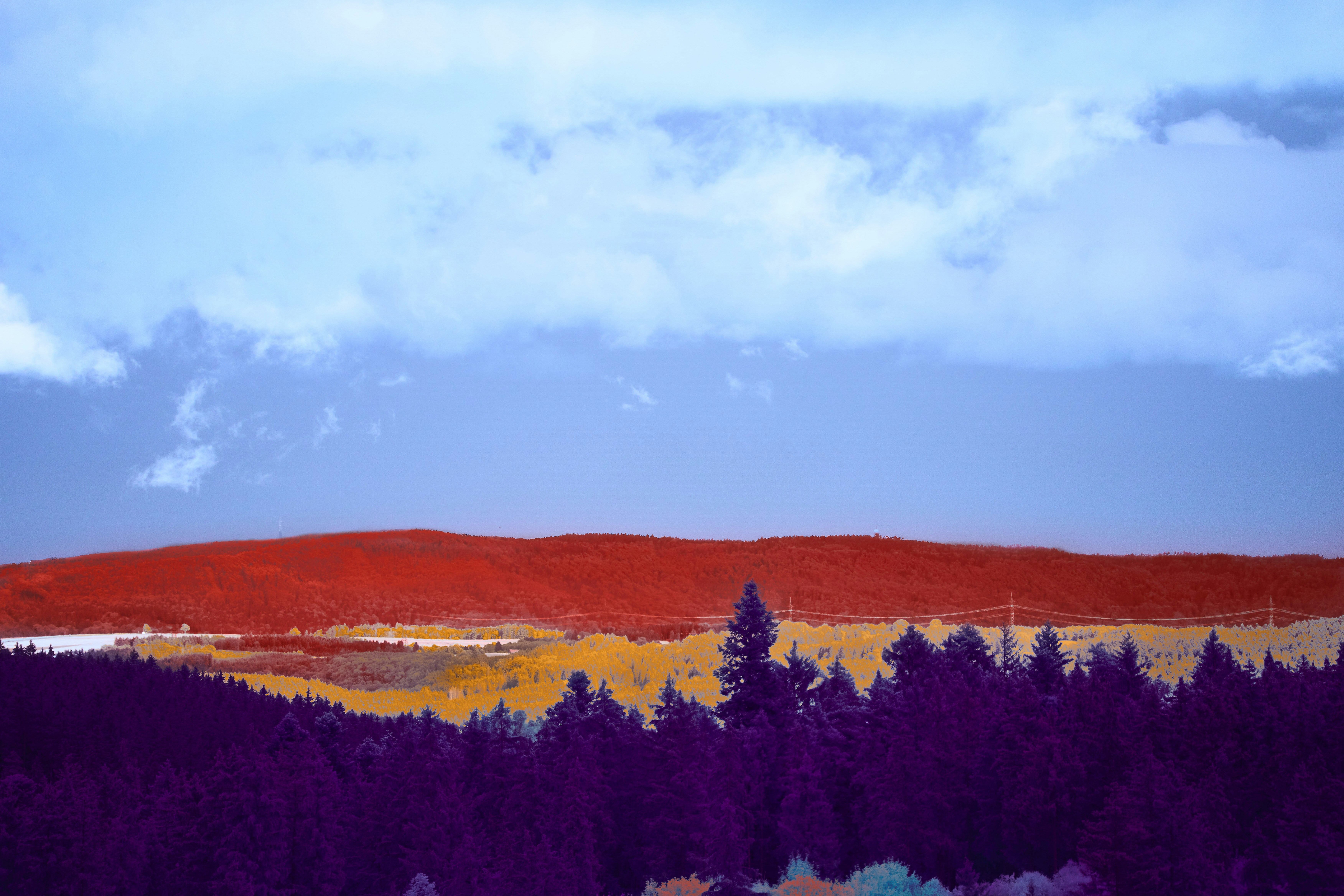 Crimson Ridge Over a Violet Forest at Dusk