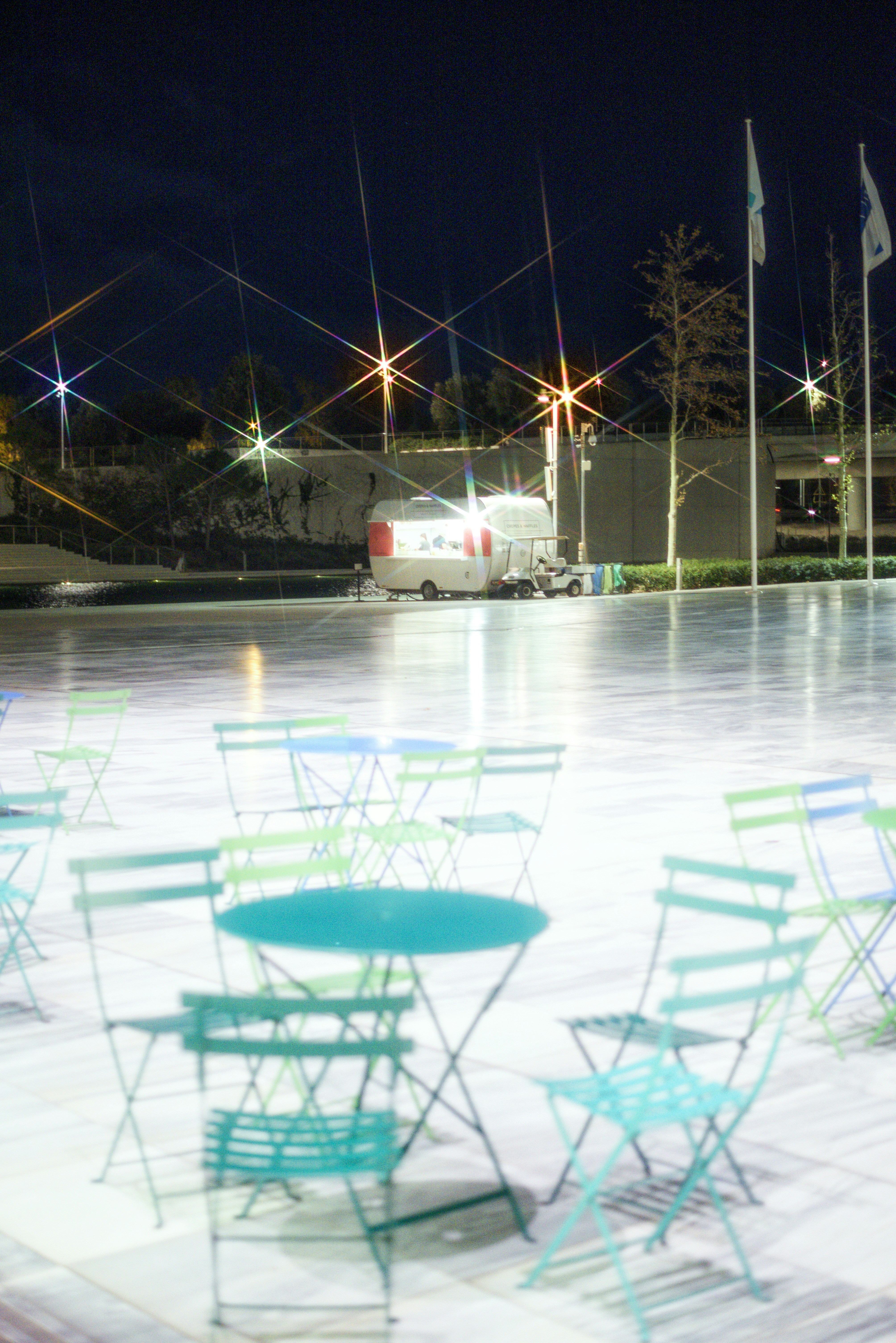 A group of chairs and tables sitting on top of a ice rink photo – Free ...