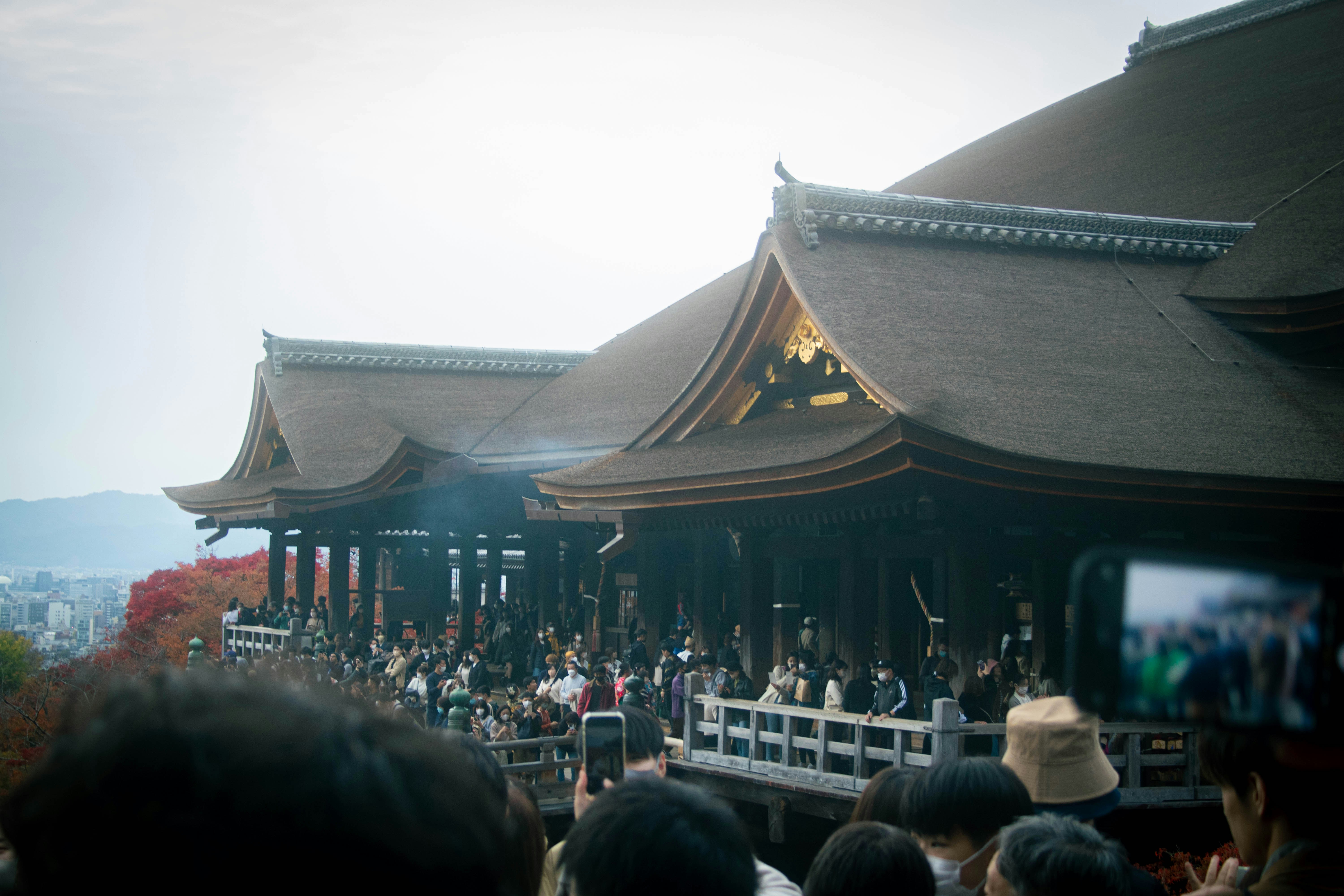 Gabled Reverie: Crowds Under the Sweeping Temple Eaves at Dusk