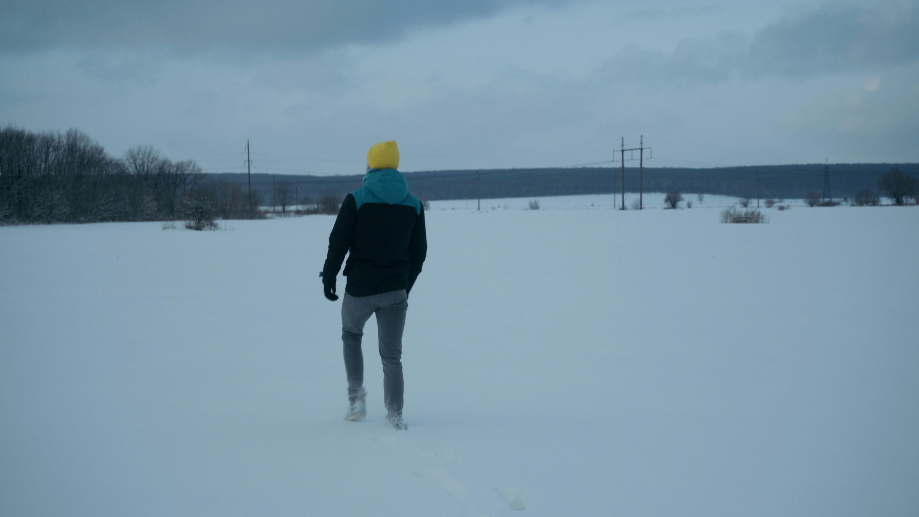 A man walking through a snow covered field photo – Free Man Image on ...