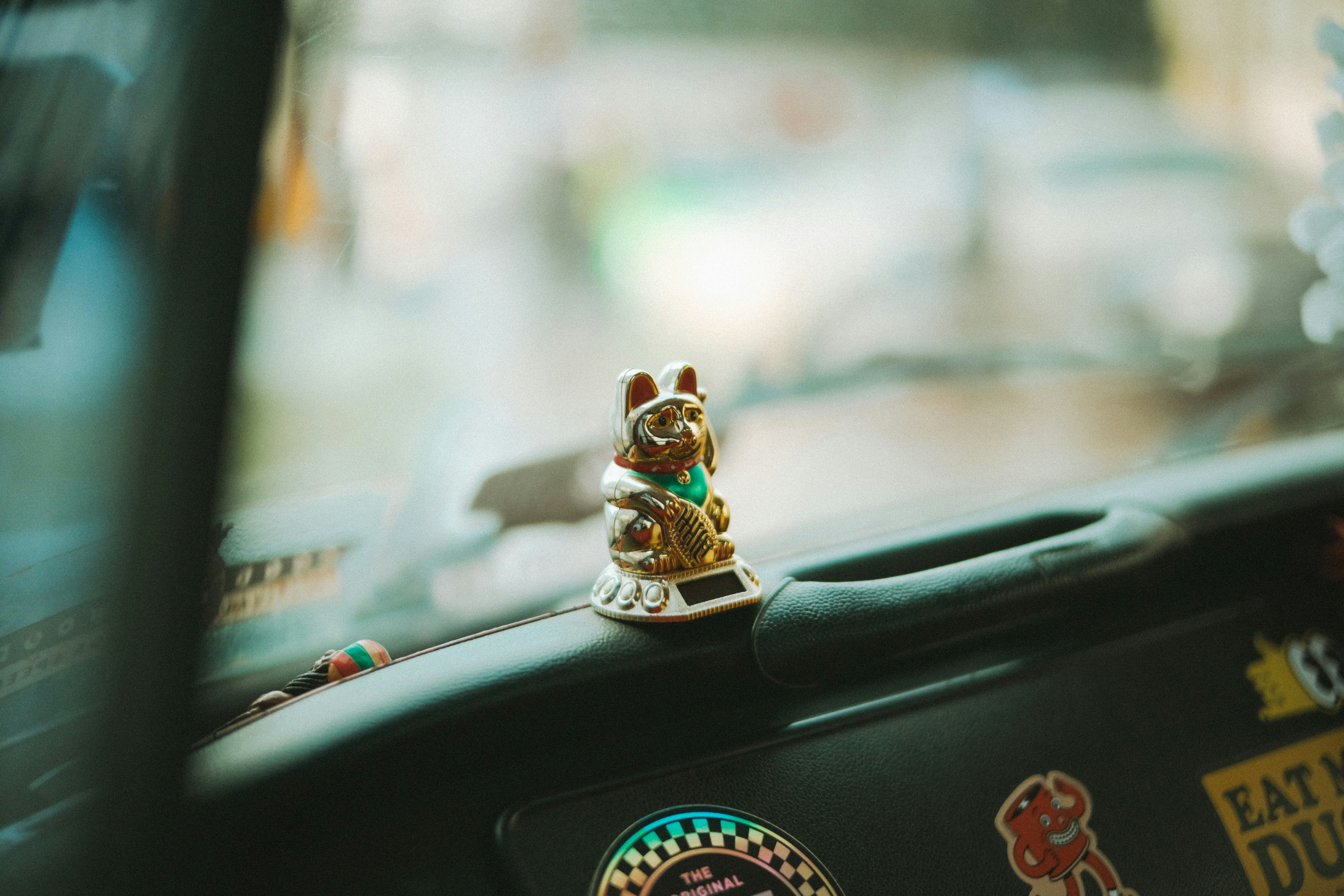 Fortune on the Dashboard: A Tiny Maneki-neko Guards the Road