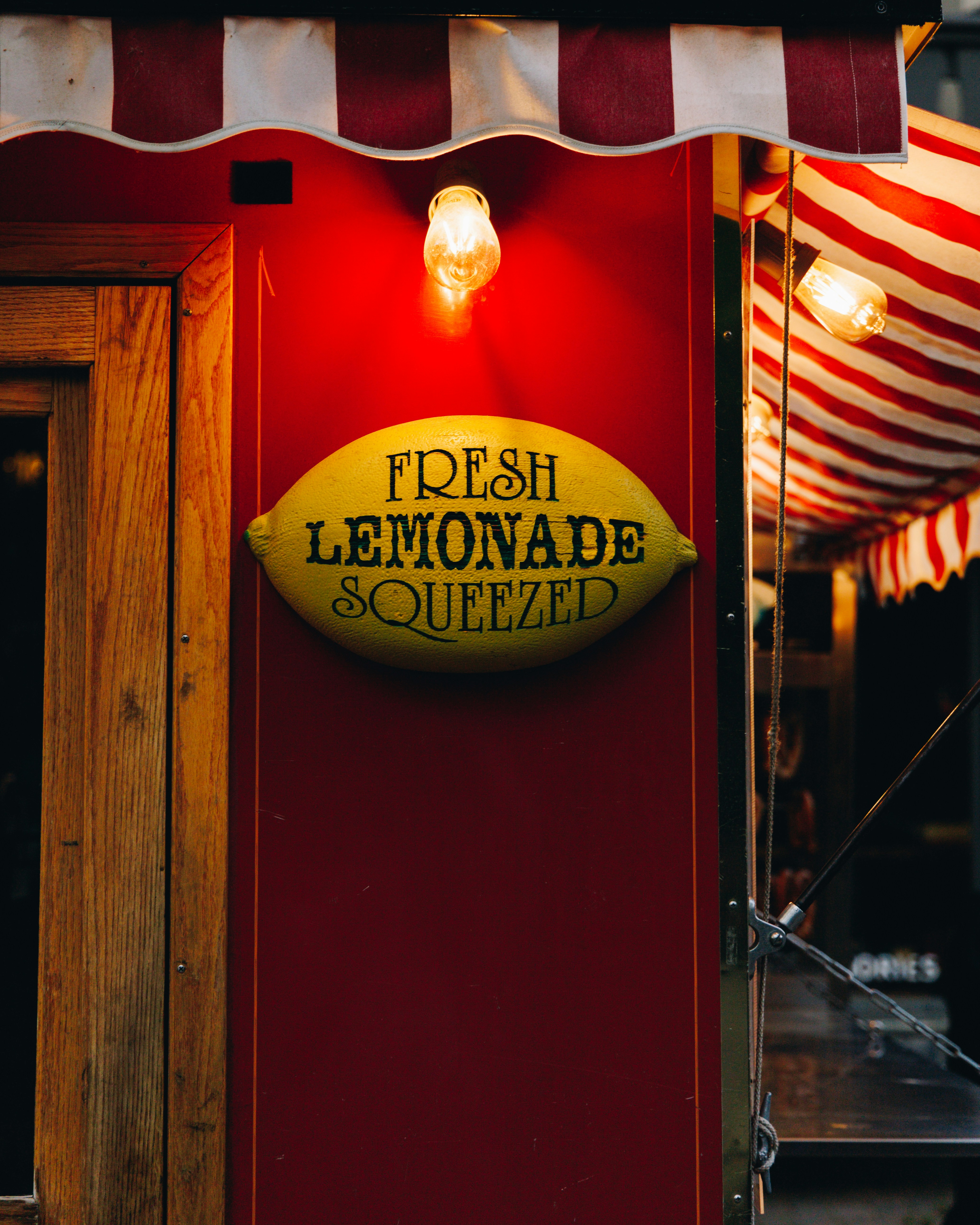 A sign on the side of a building that says fresh lemonade and squeezed ...
