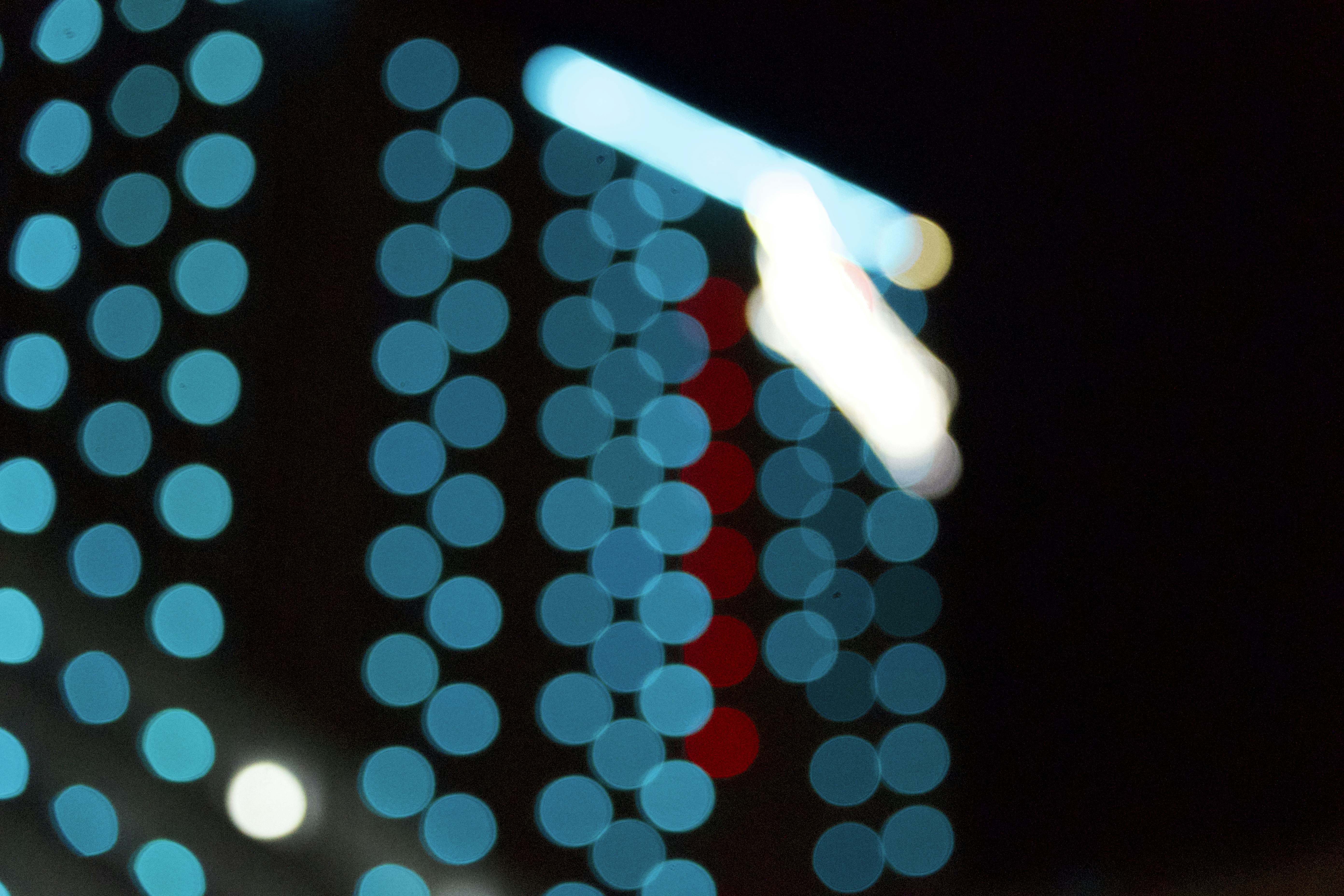 a blurry photo of a street sign with lights in the background