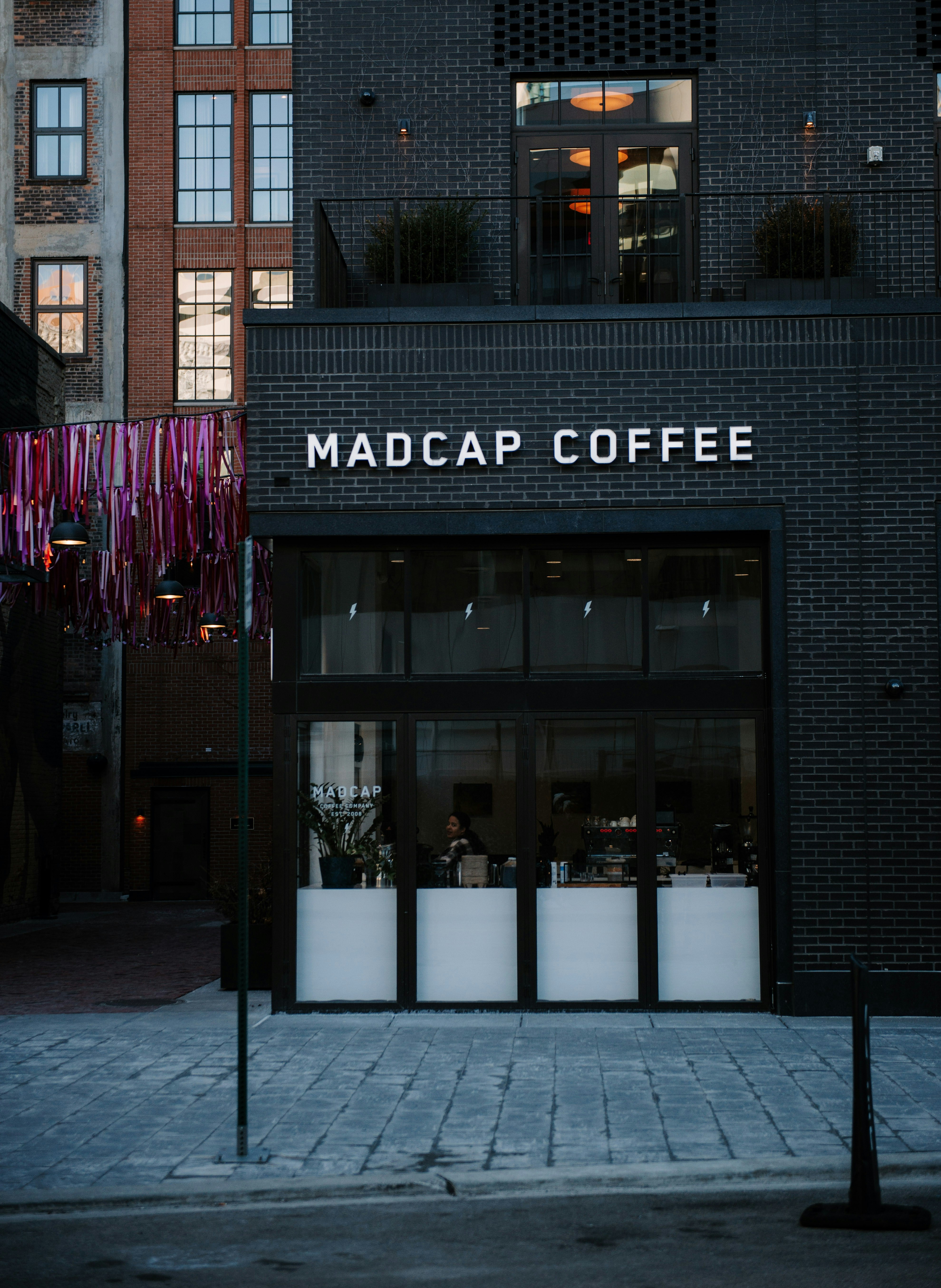 A building with a sign that says madcap coffee photo – Free City Image ...