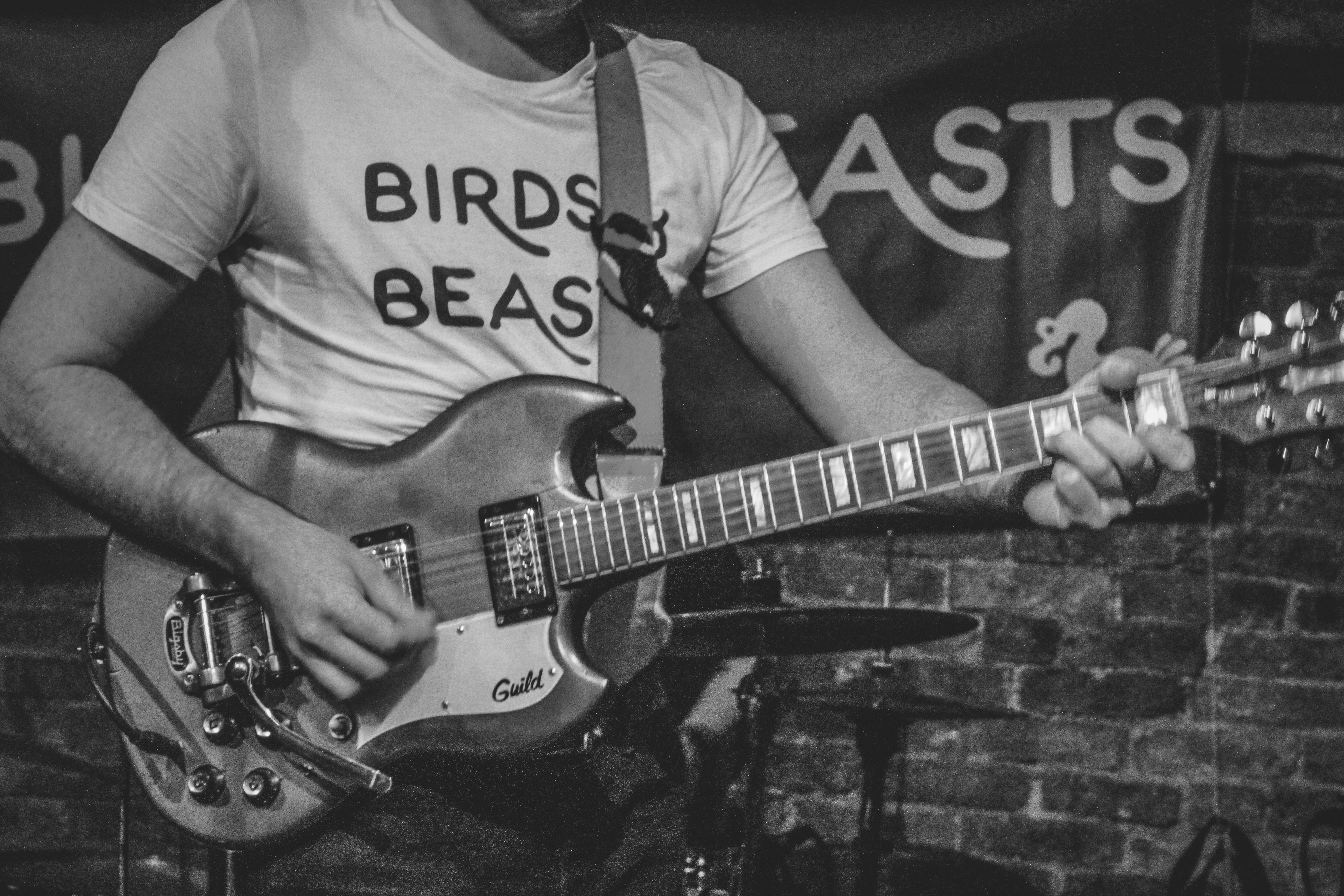 Noir on the Frets: Brick-Walled Gig in Mono