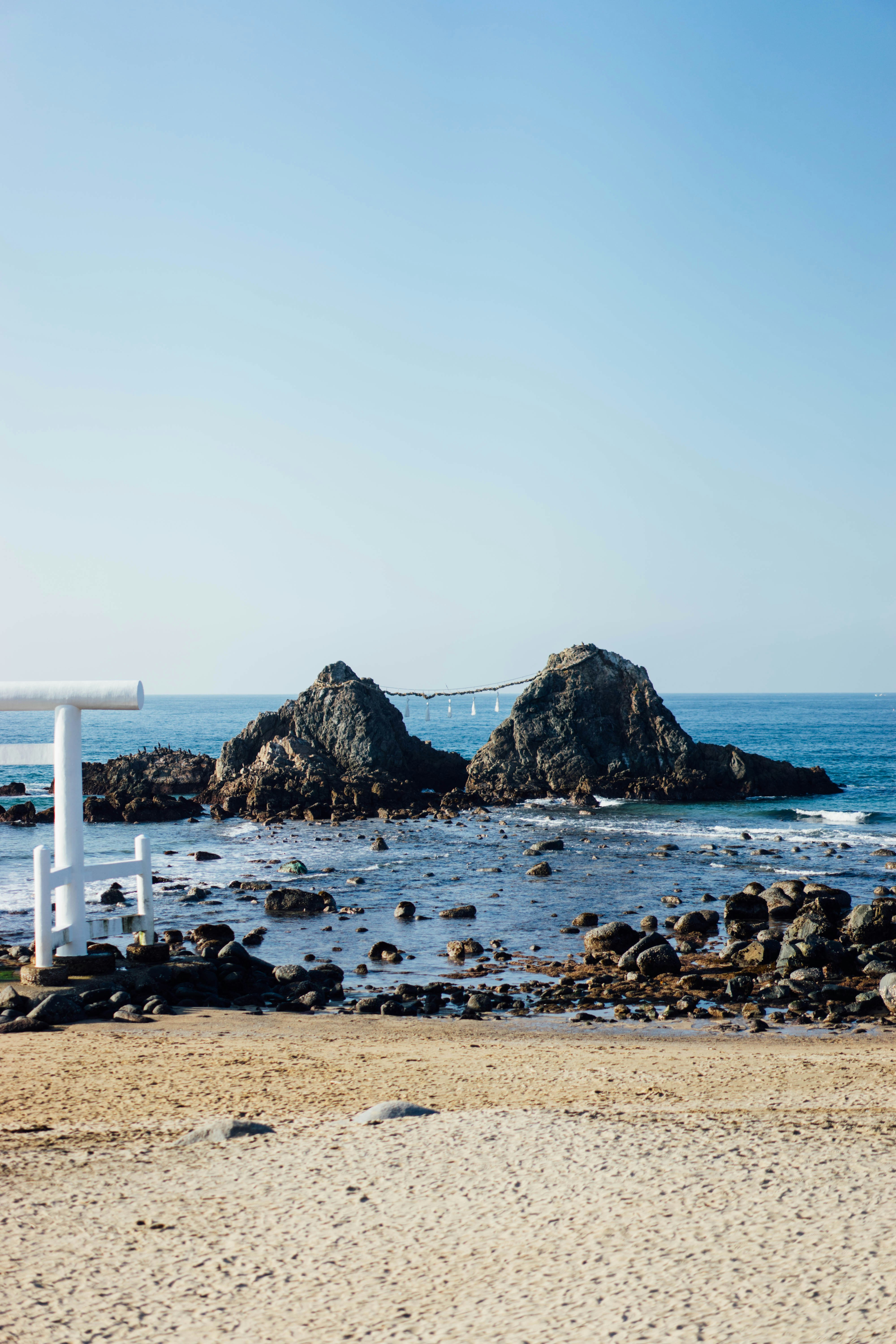 Rock Sentinels at Calm Coastal Horizon