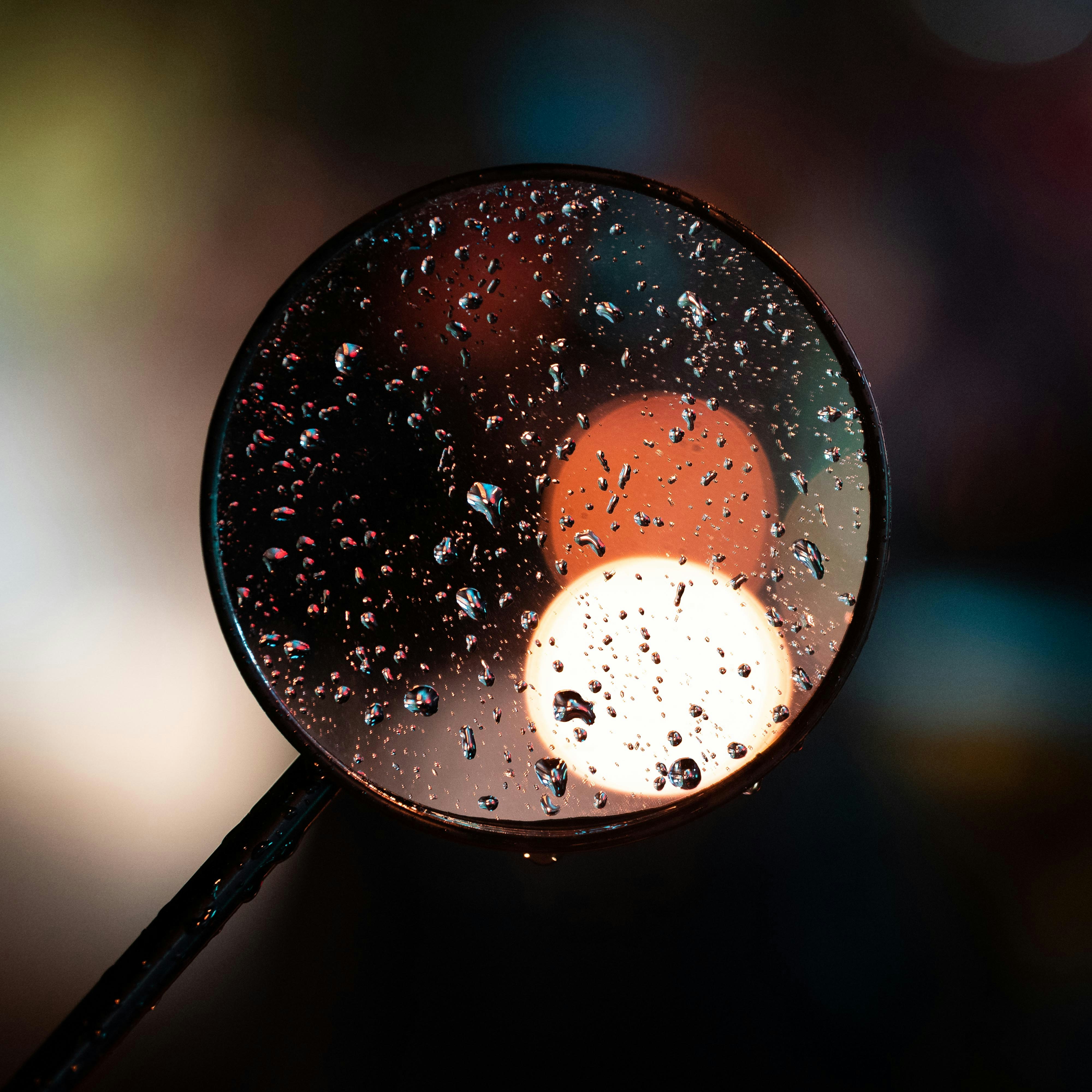 Magnified Droplets: The Lens as a Playground