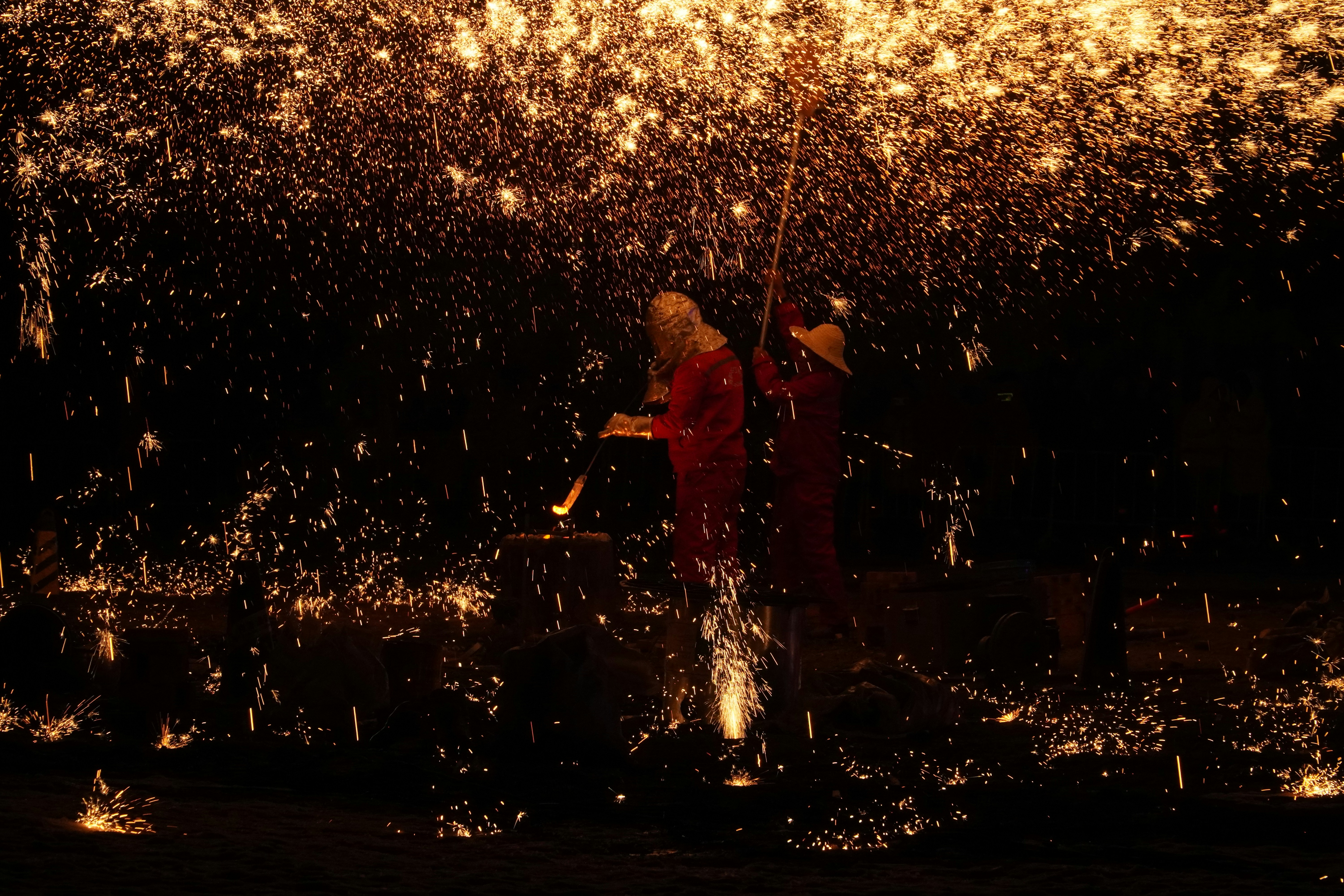 A couple of people standing in front of a fire hydrant photo – Free ...