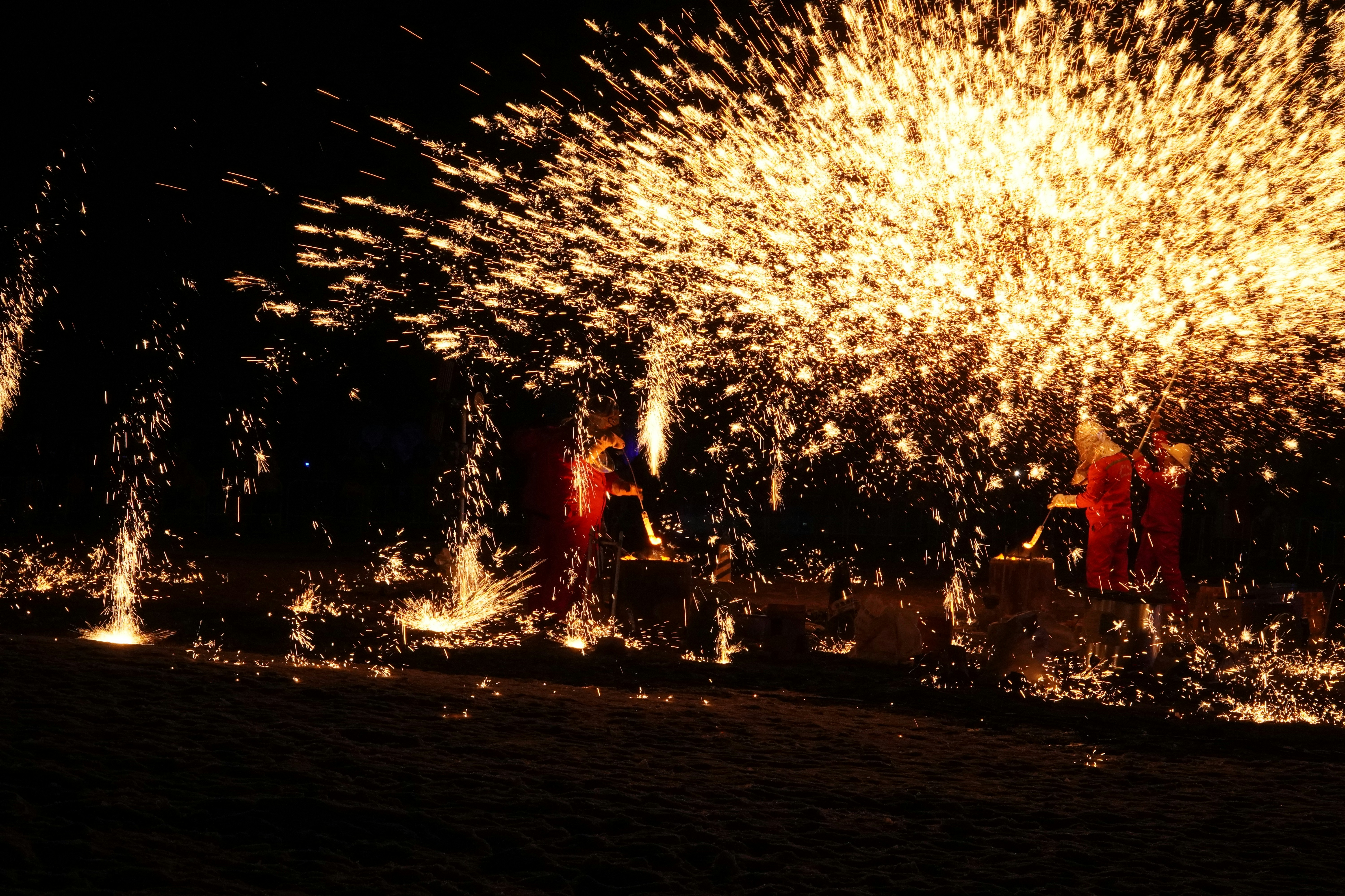 A group of people standing around a firework display photo – Free Human ...