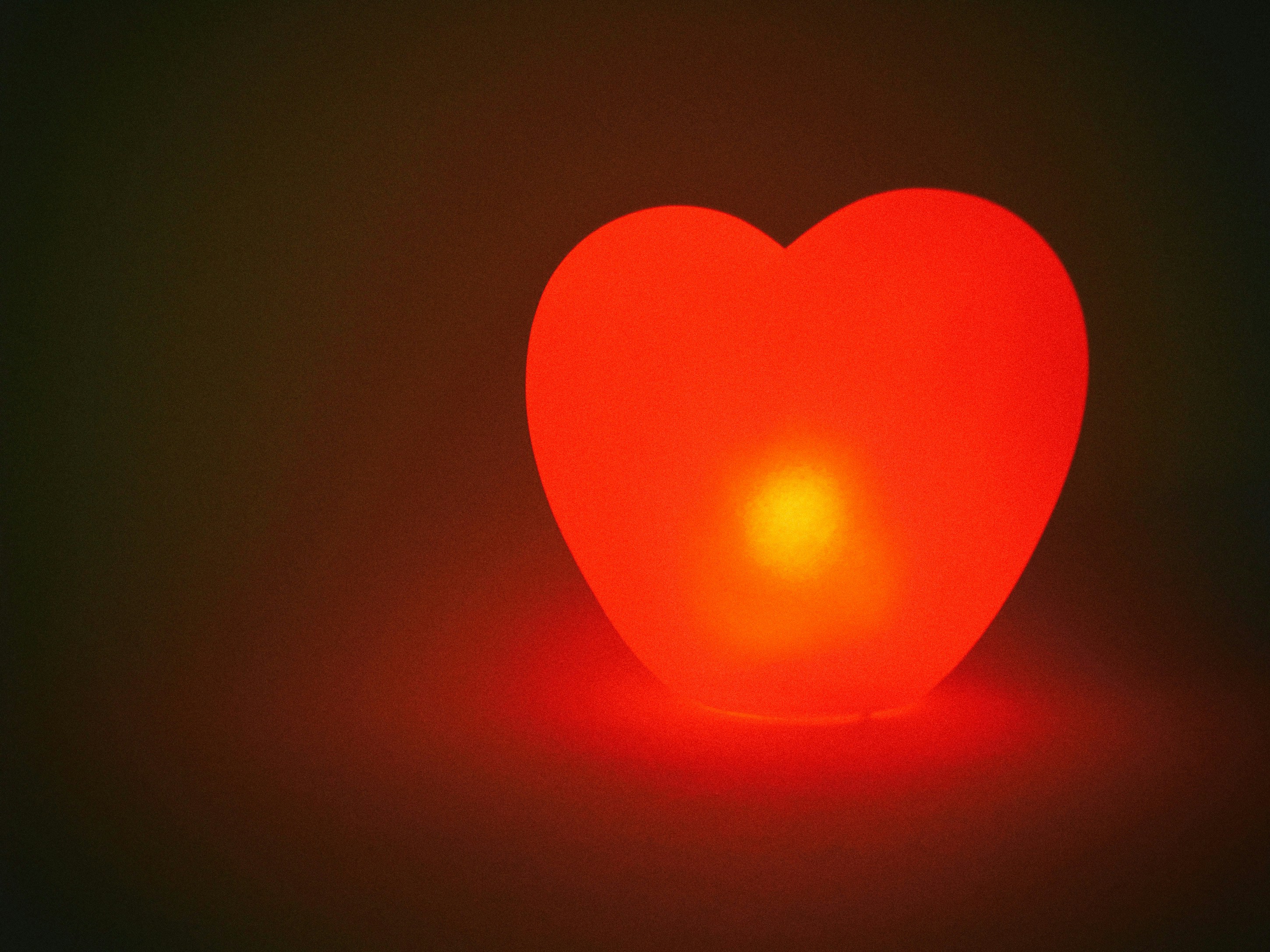 Crimson Halo: a solitary heart glow against velvet darkness