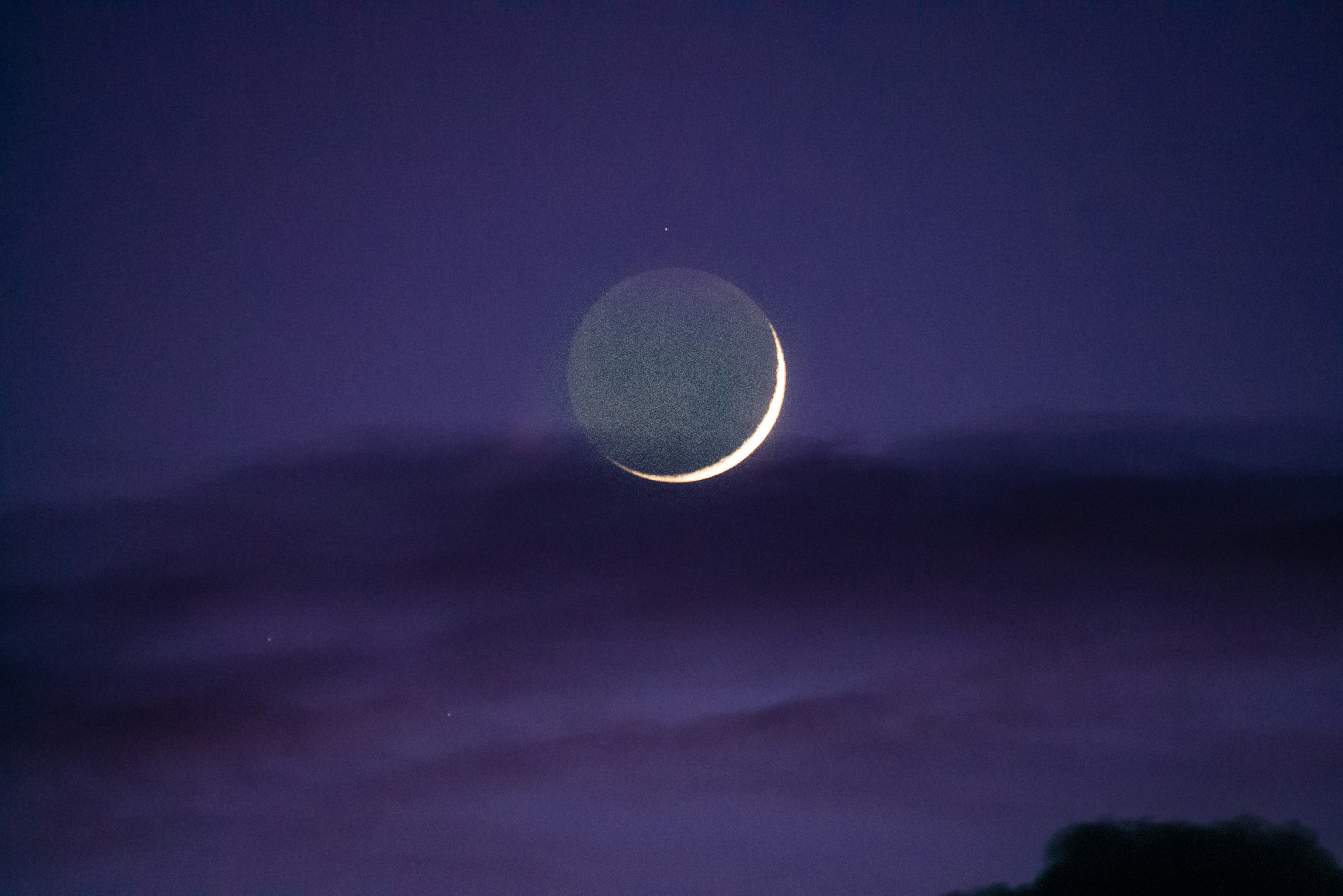 A crescent moon is seen in the night sky photo – Free Moon Image on ...