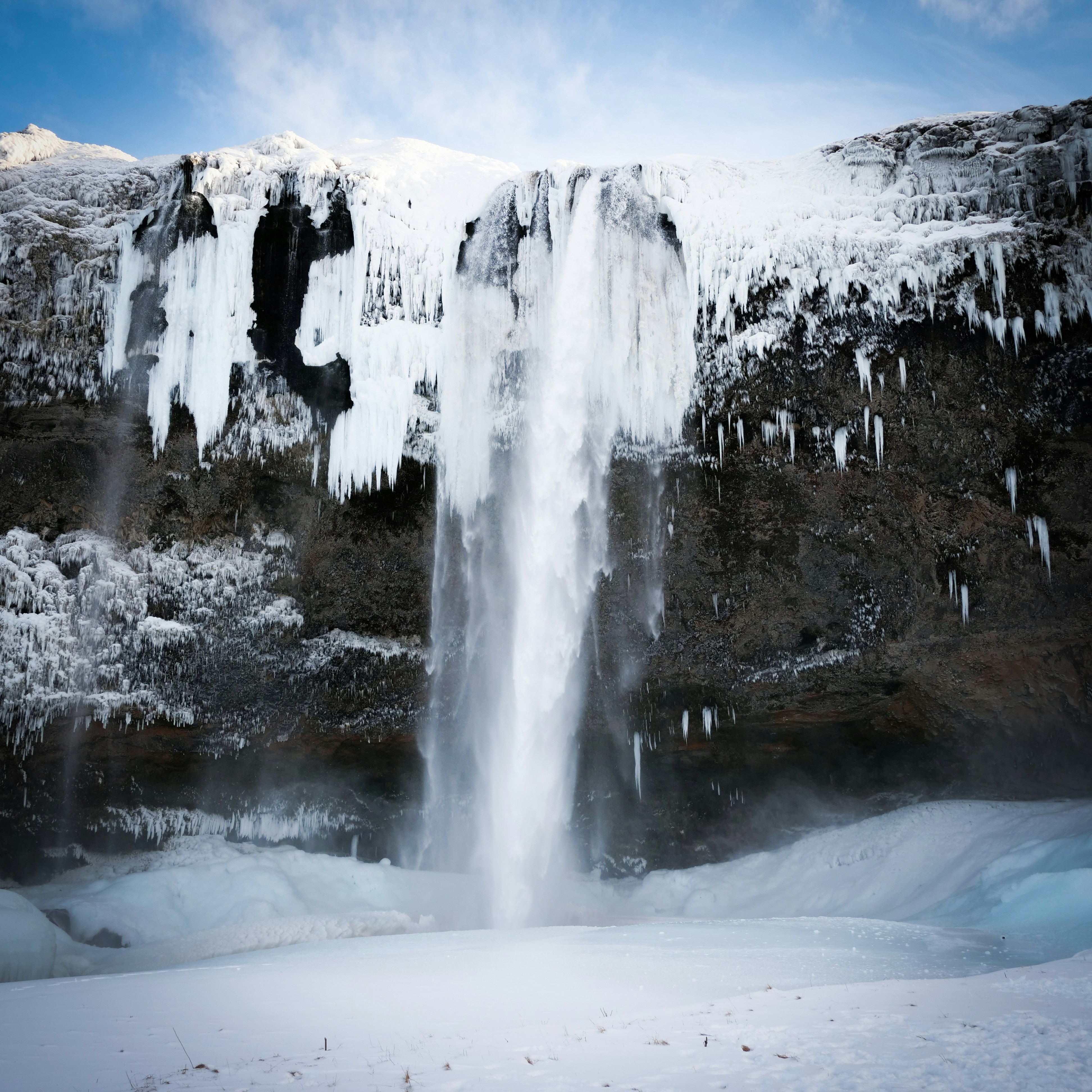 A large waterfall with snow on the ground photo – Free Seljalandsfoss ...