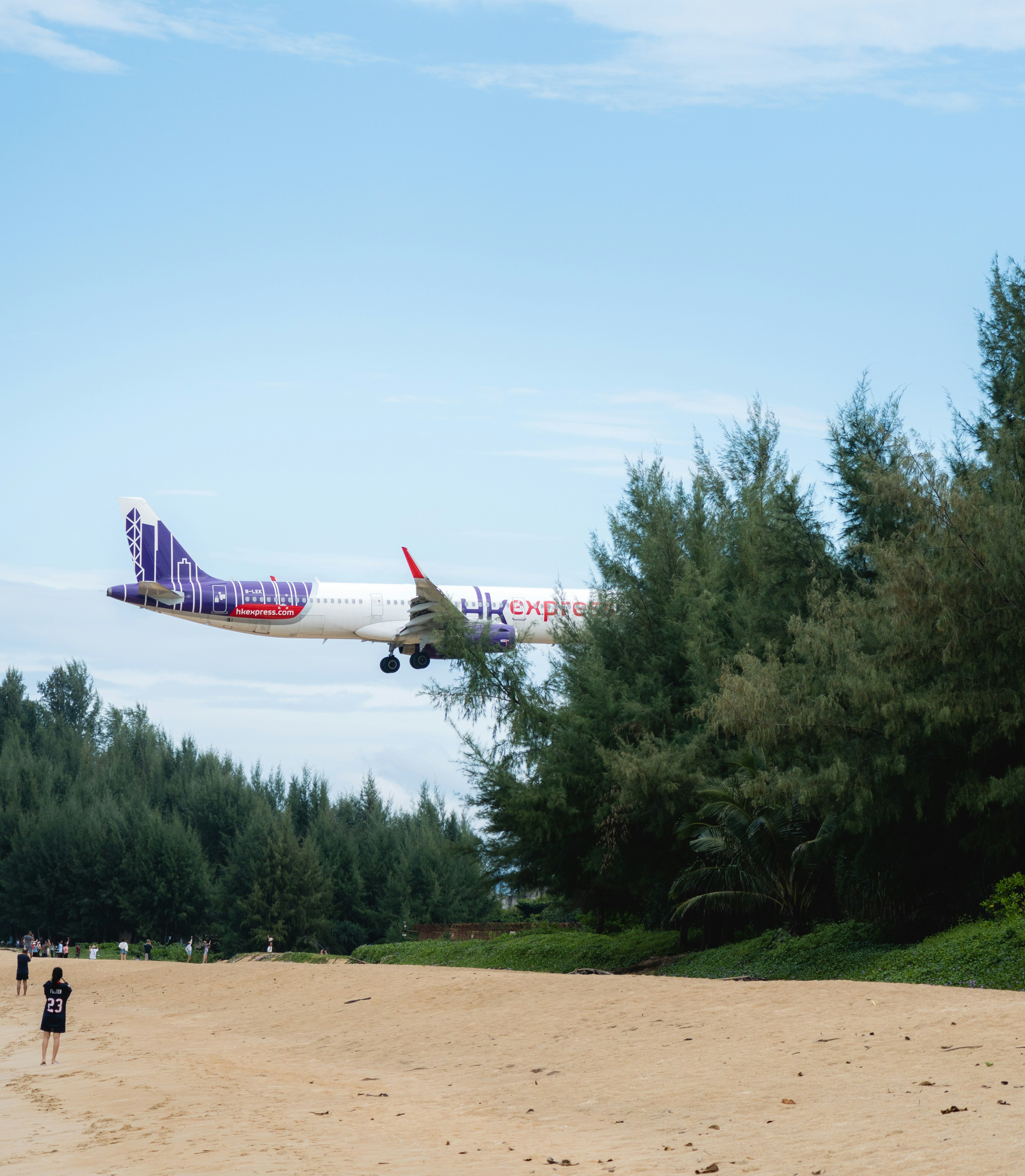 A plane is flying low over a beach photo – Free Mai khao beach Image on ...