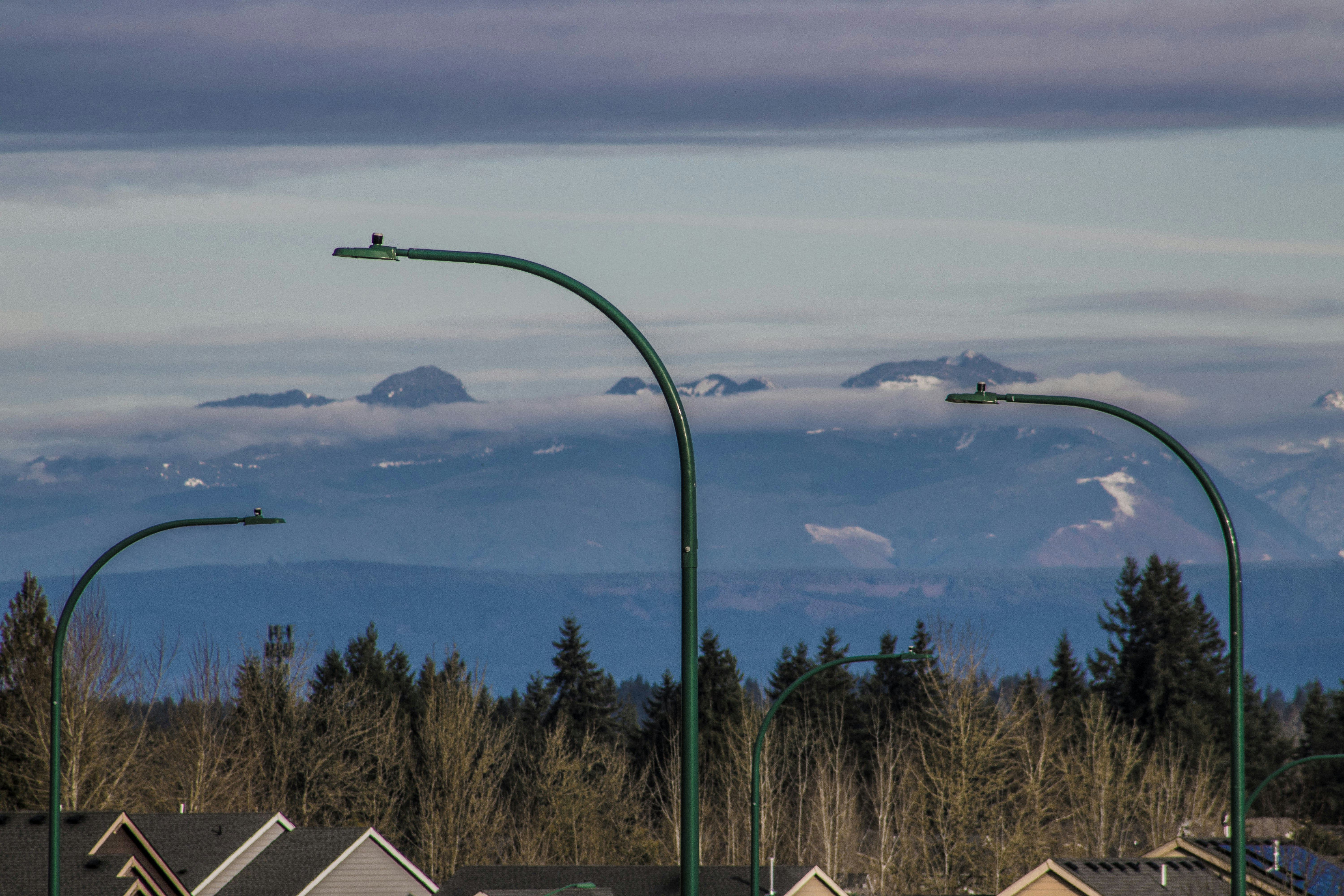 Green Curves Over a Quiet Horizon: Streetlamps Framing the Mountains