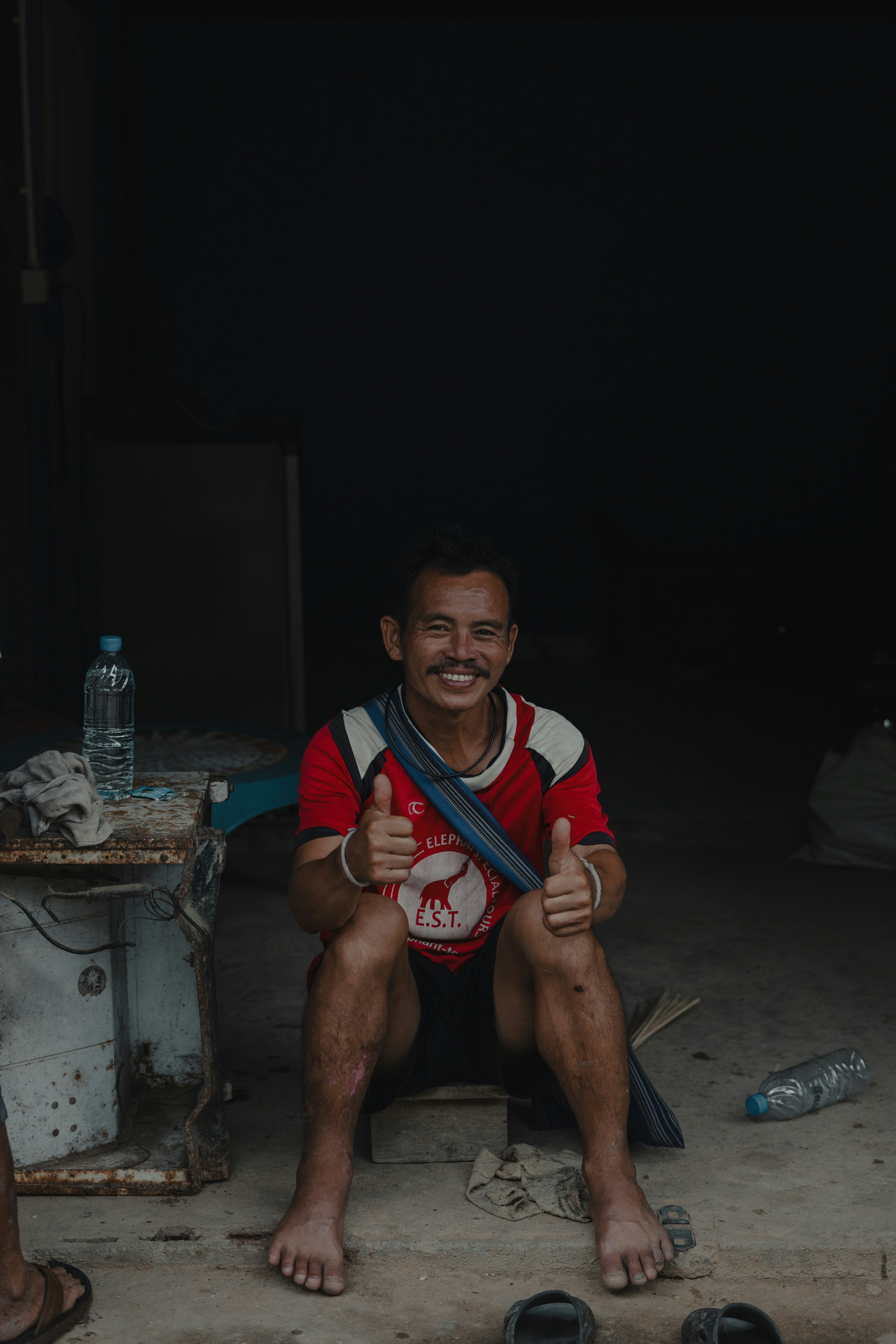 Thumbs Up in the Shadows: A Portrait from a Dim Workshop