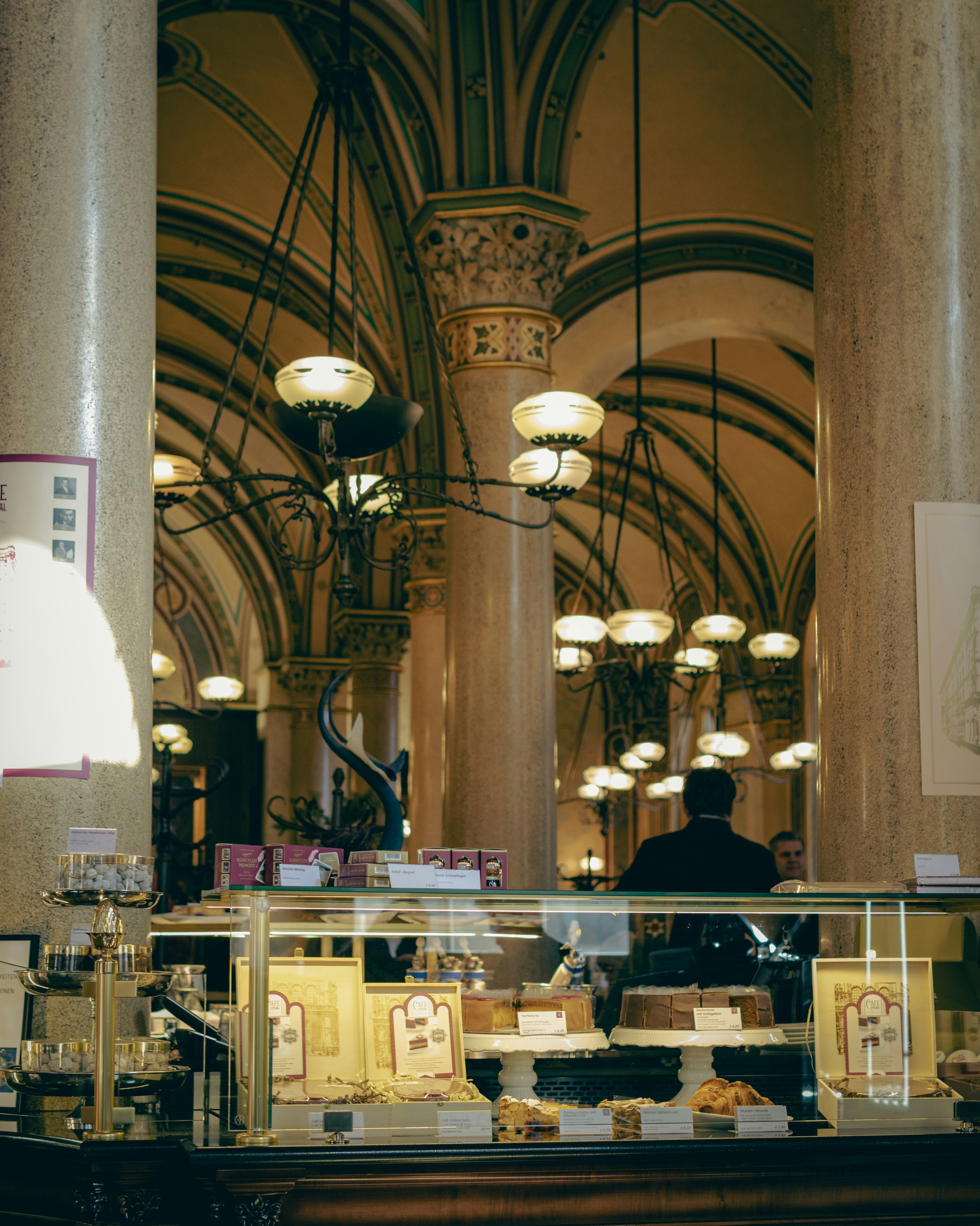 A man standing behind a counter in a restaurant photo – Free Building ...