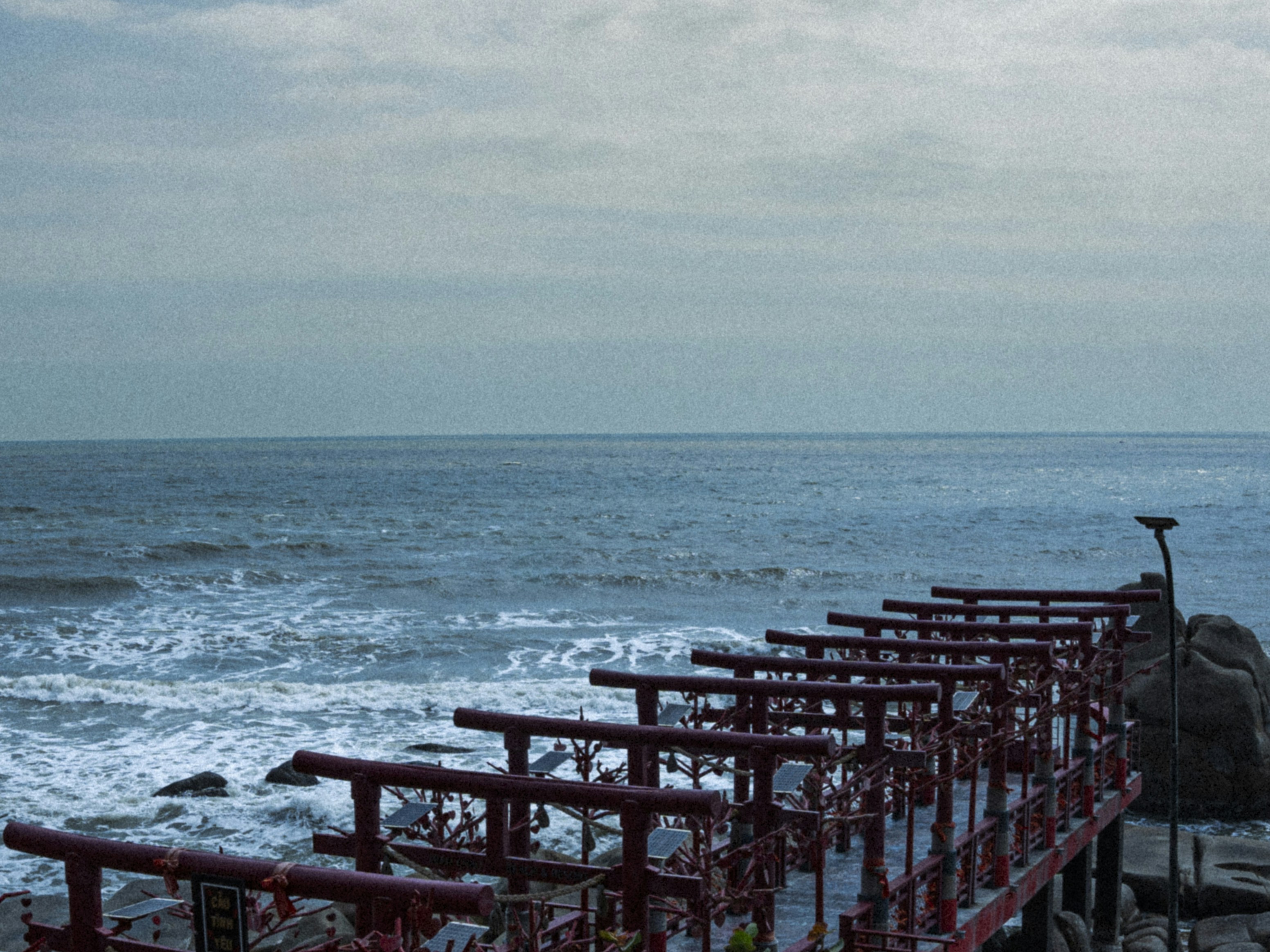 A red fire hydrant sitting next to the ocean photo – Free Vietnam Image ...
