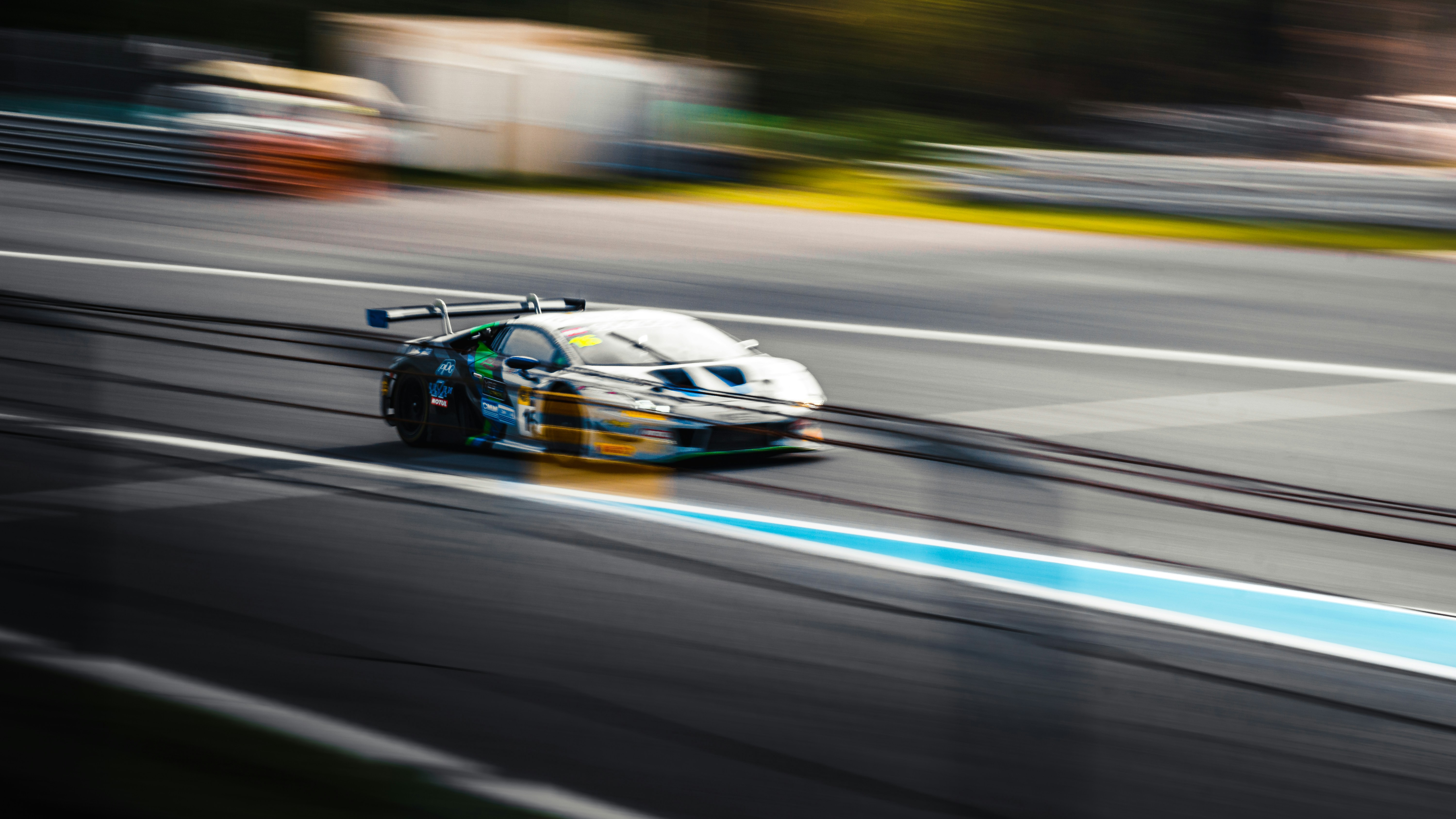 A race car driving down a race track photo – Free Monza Image on Unsplash