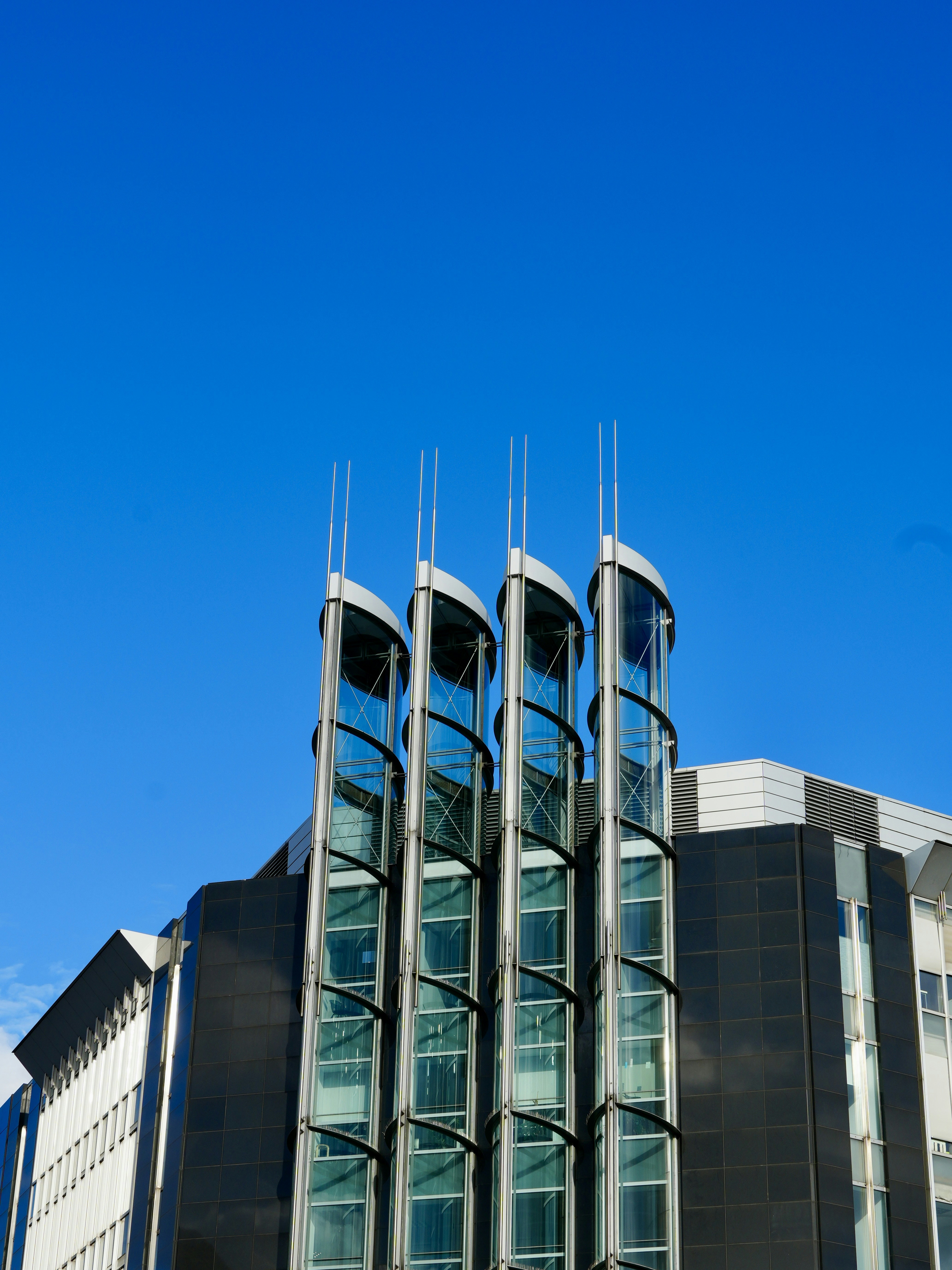 Crown of Glass and Steel: Vertical Fins Rise Beneath a Pristine Blue Sky