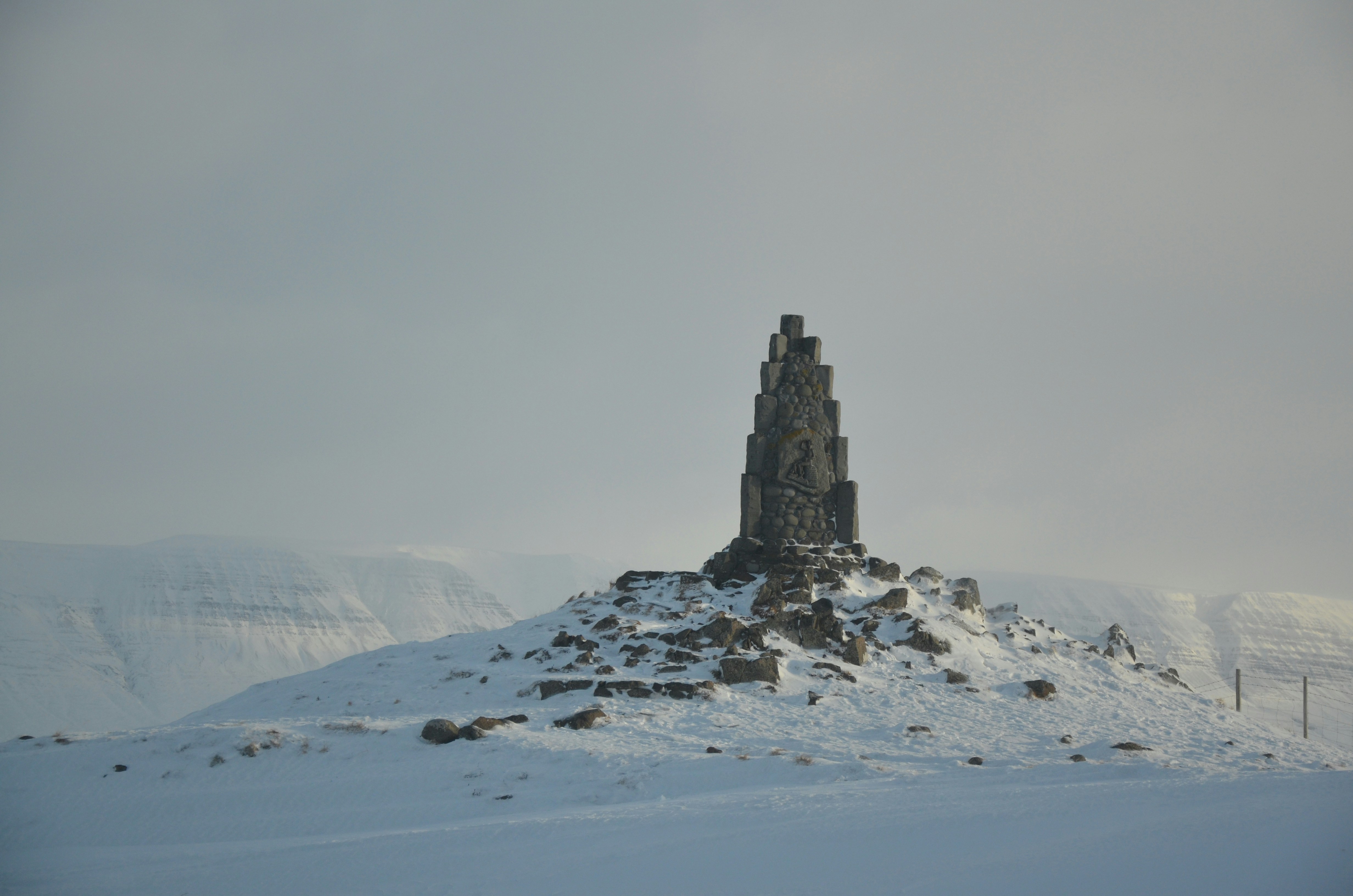 A tall tower sitting on top of a snow covered hill photo – Free Winter ...