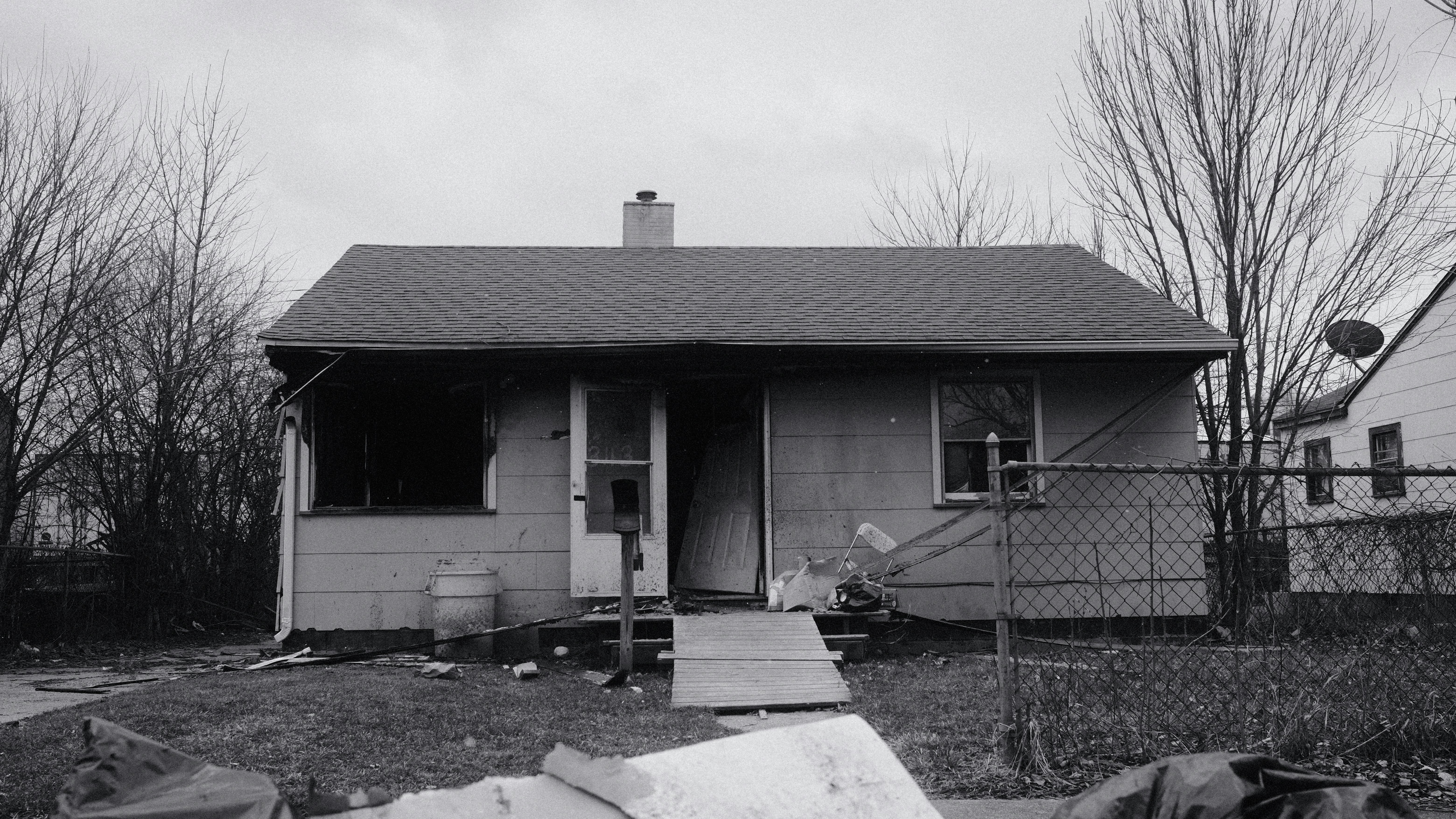 Weathered Front: A Monochrome Portrait of a Suburban Dwelling in Decay