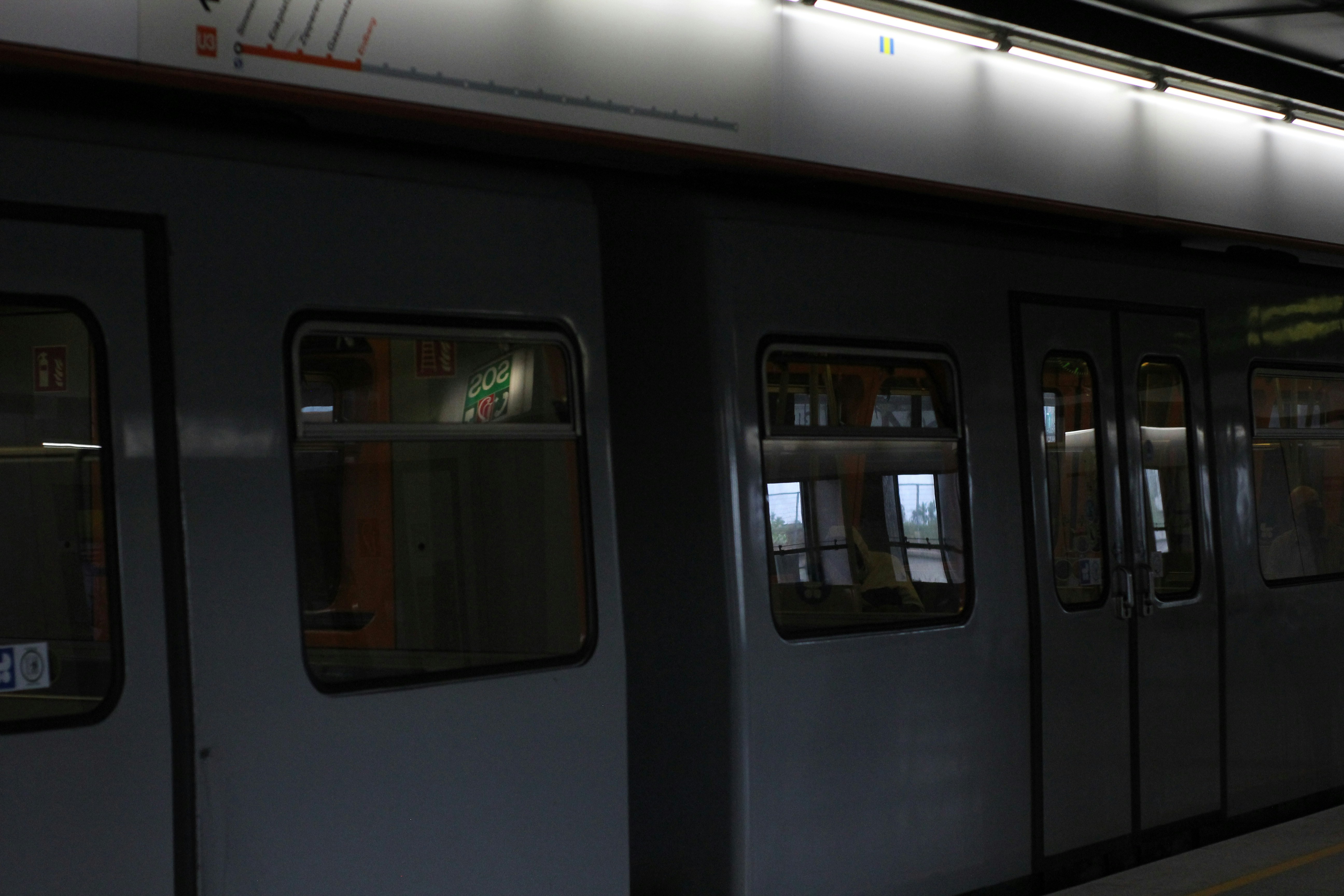 Dim Platform Pulse: Reflections and Steel in a Suburban Subway Car