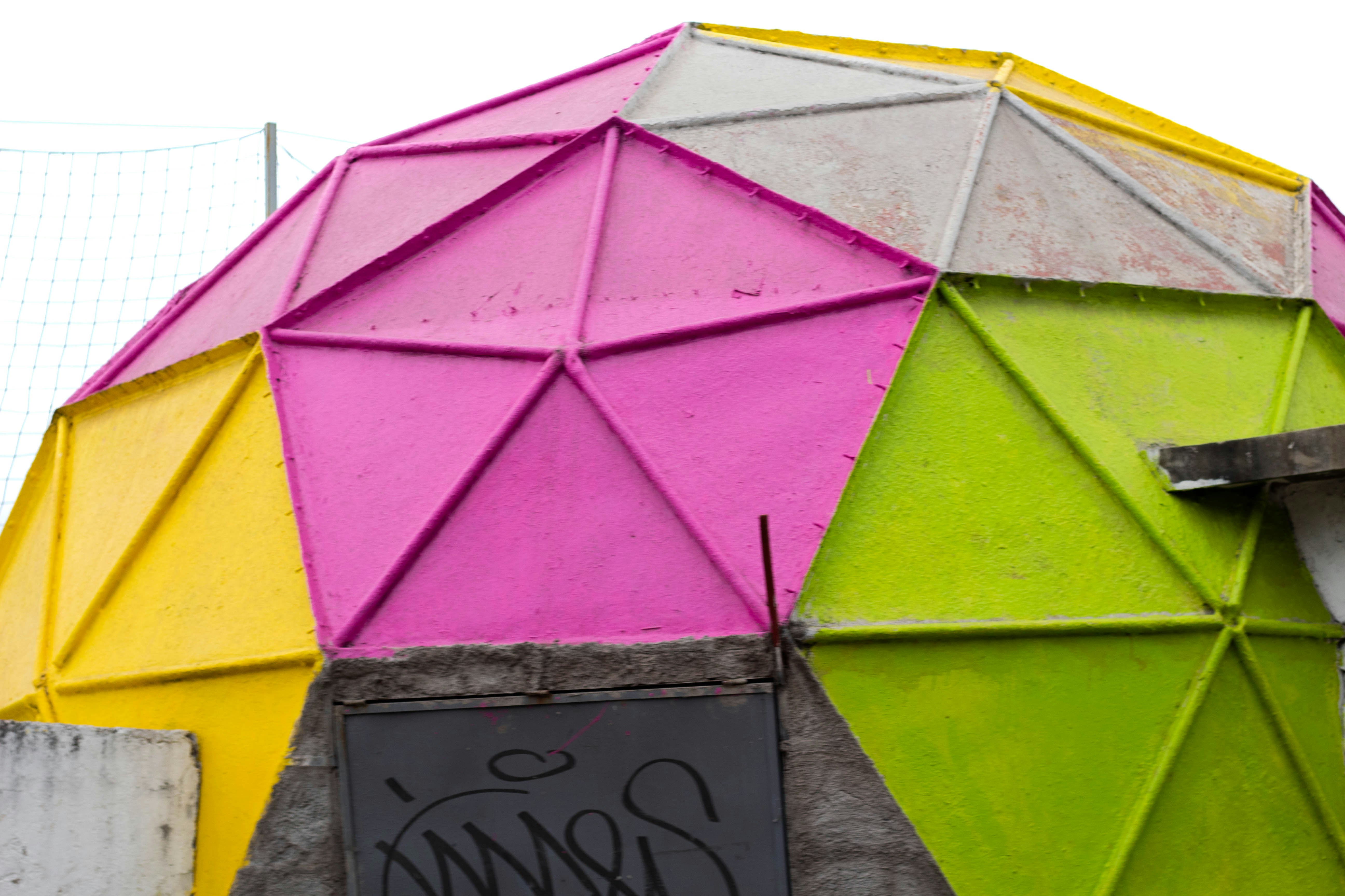 Pink-Capped Geodesic Dome: A Playful Mosaic of Neon Panels