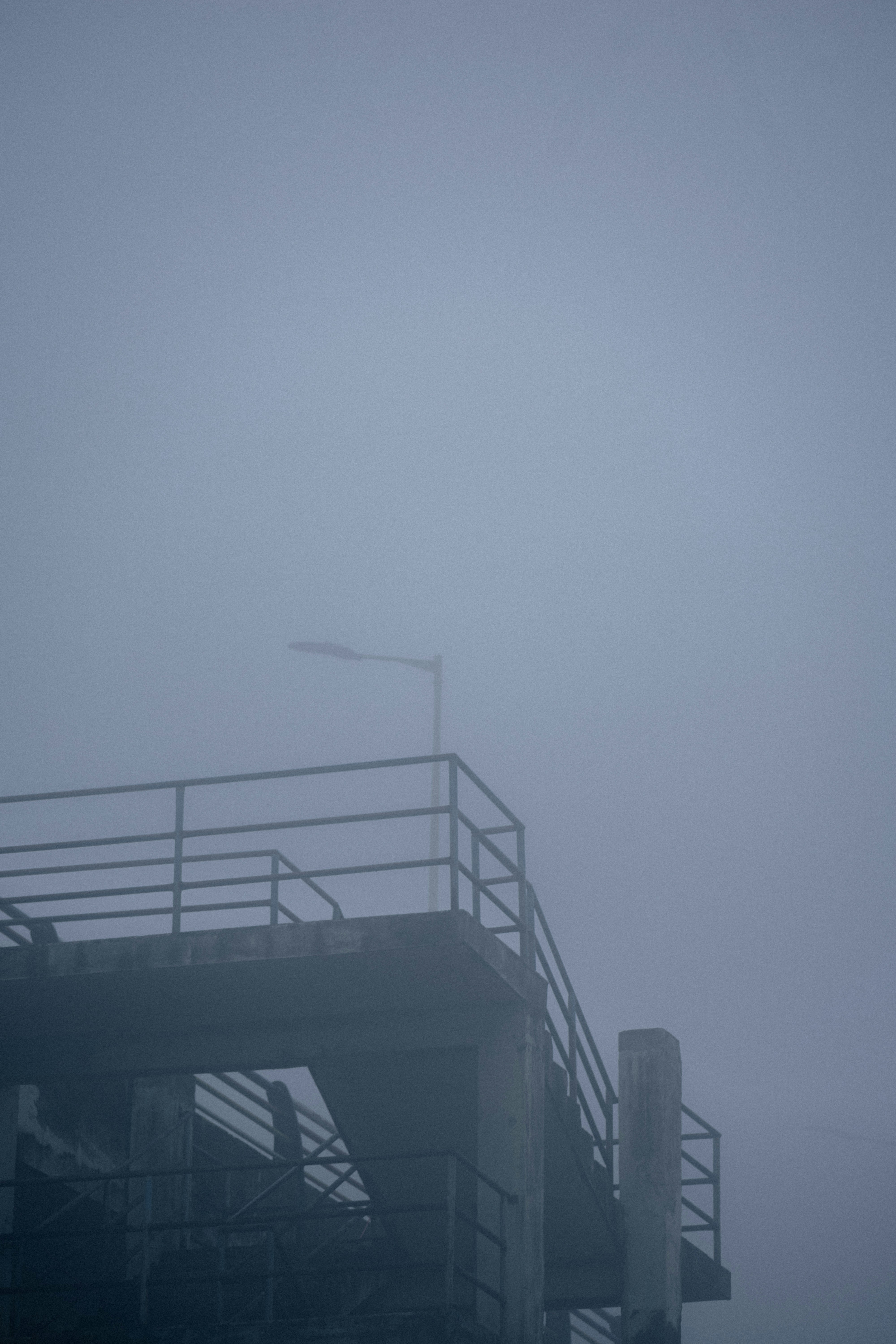 Blue Silence at the Fog-Wreathed Pier