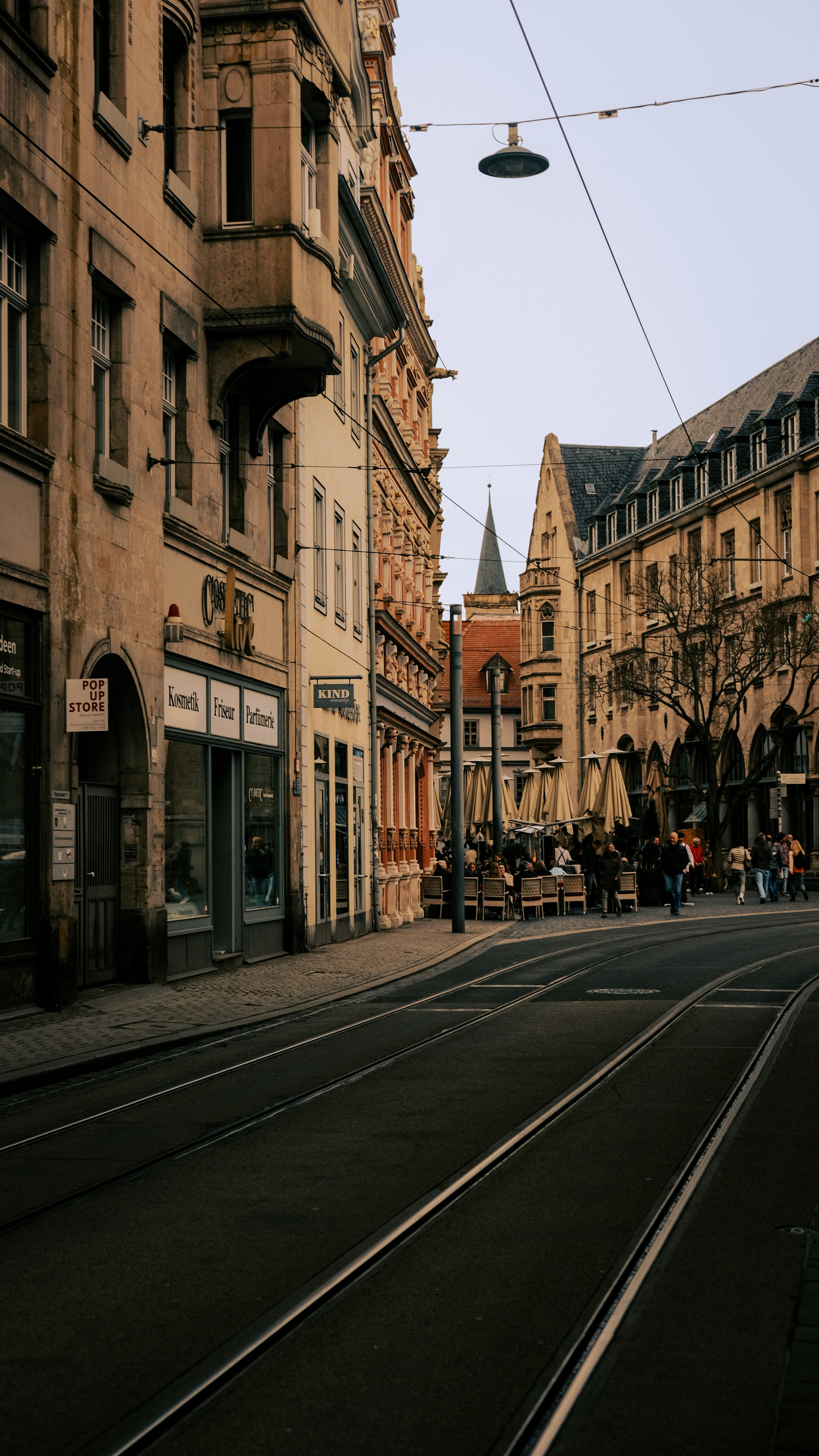 Convergence on Cobblestones: Rails Toward a Distant Spire