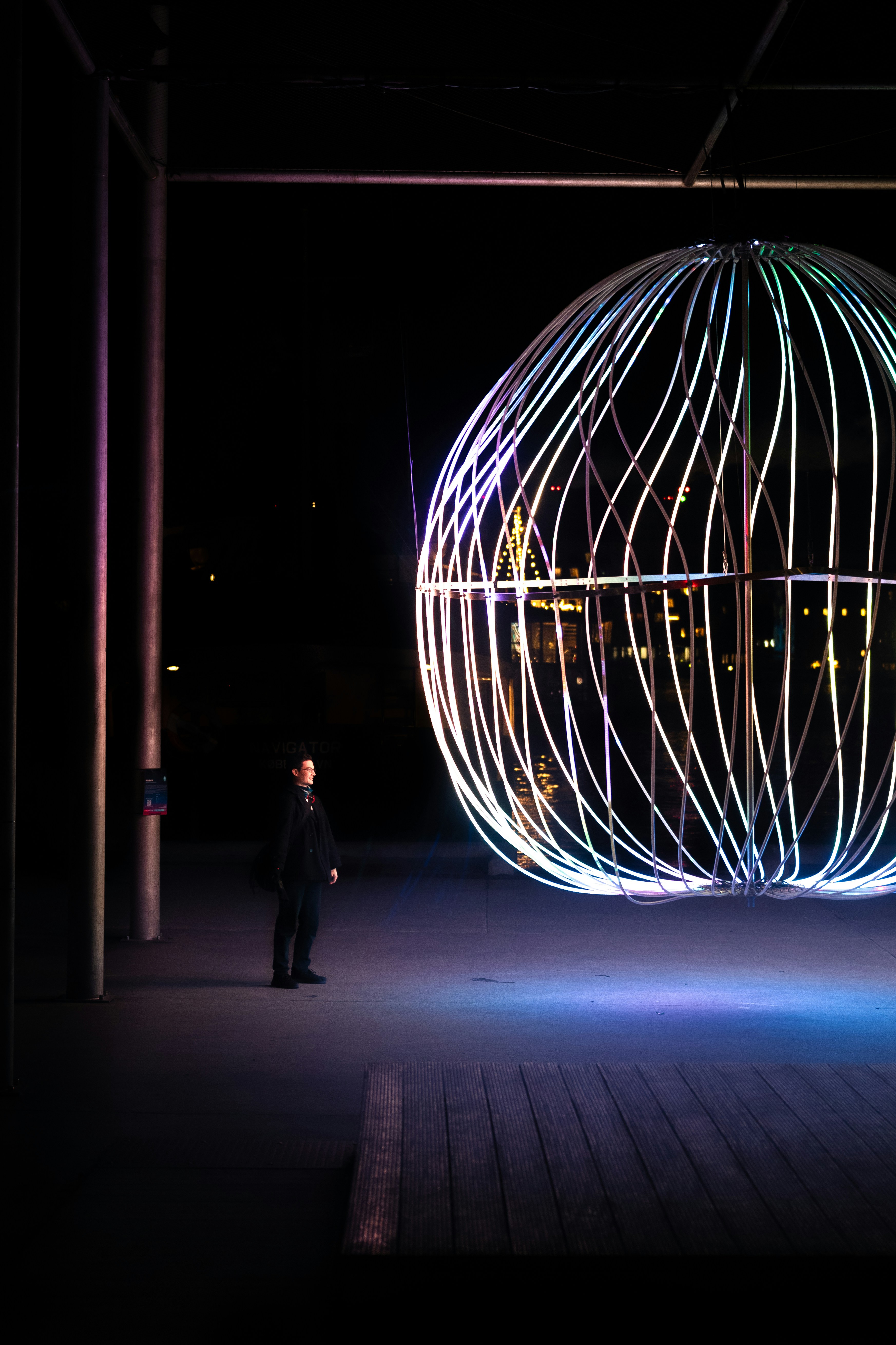 A man standing in front of a large light ball photo – Free Night Image ...