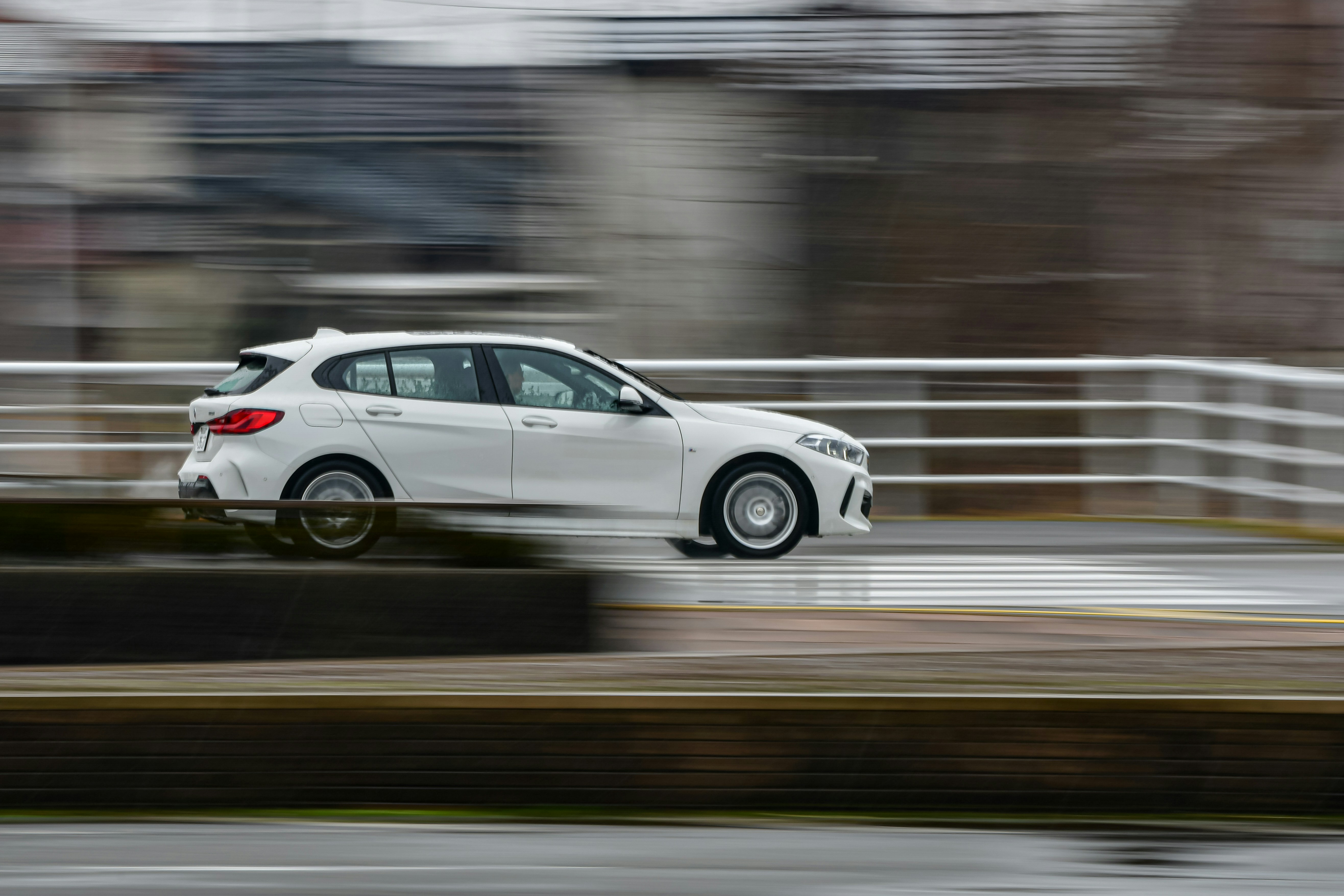 A white car driving down a wet road photo – Free Japan Image on Unsplash